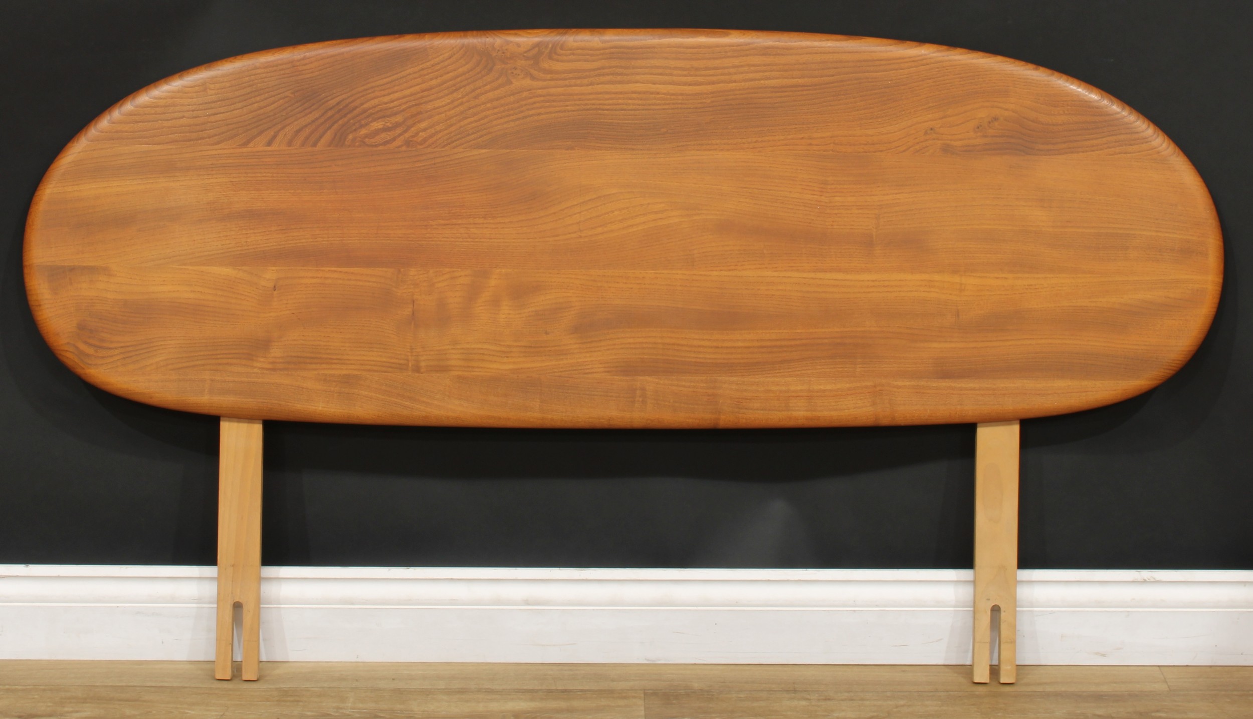 An Ercol elm headboard, 146cm wide