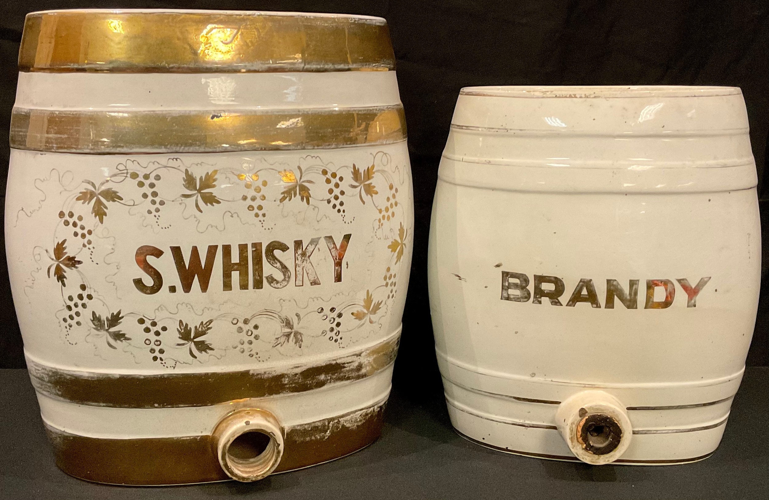 A large Victorian Scotch Whisky barrel; another, Brandy, smaller
