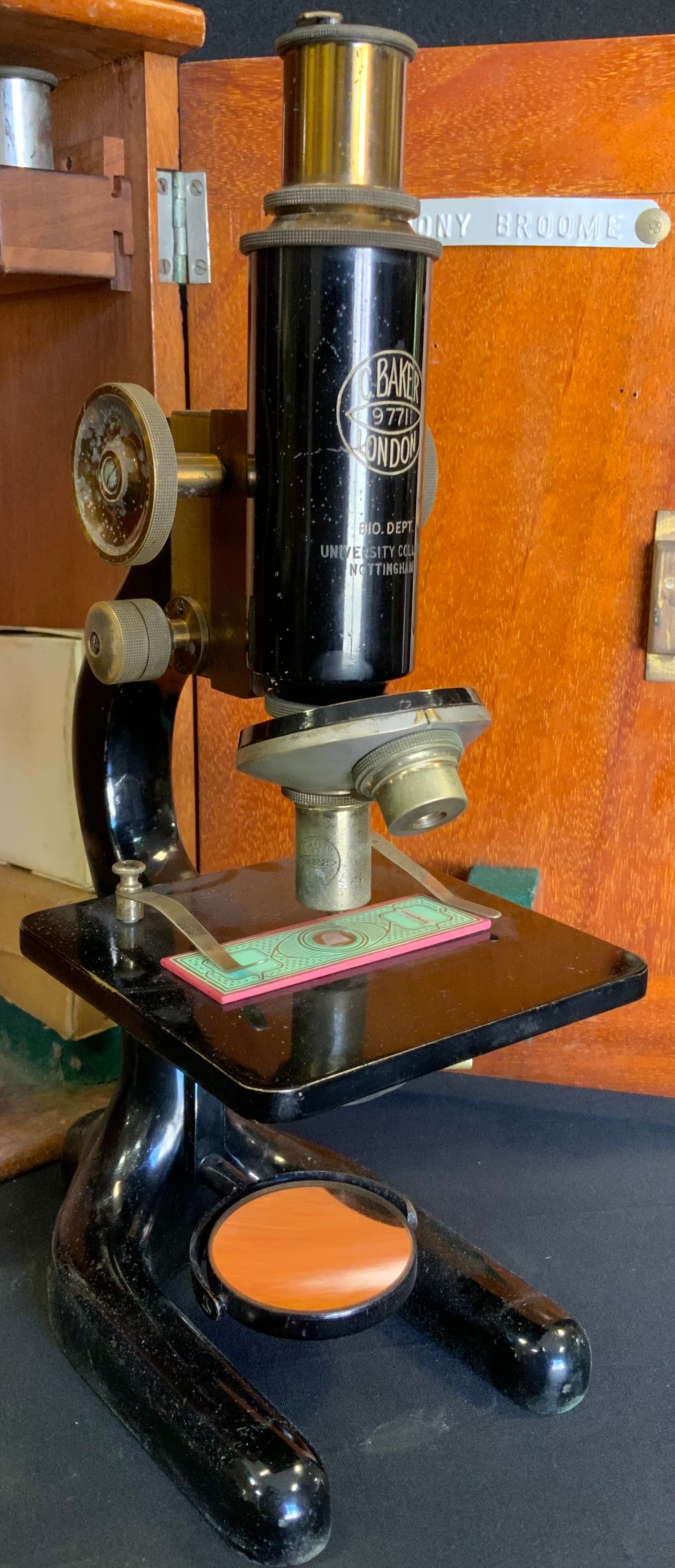 A C Baker black lacquered monocular microscope, cased, with slides