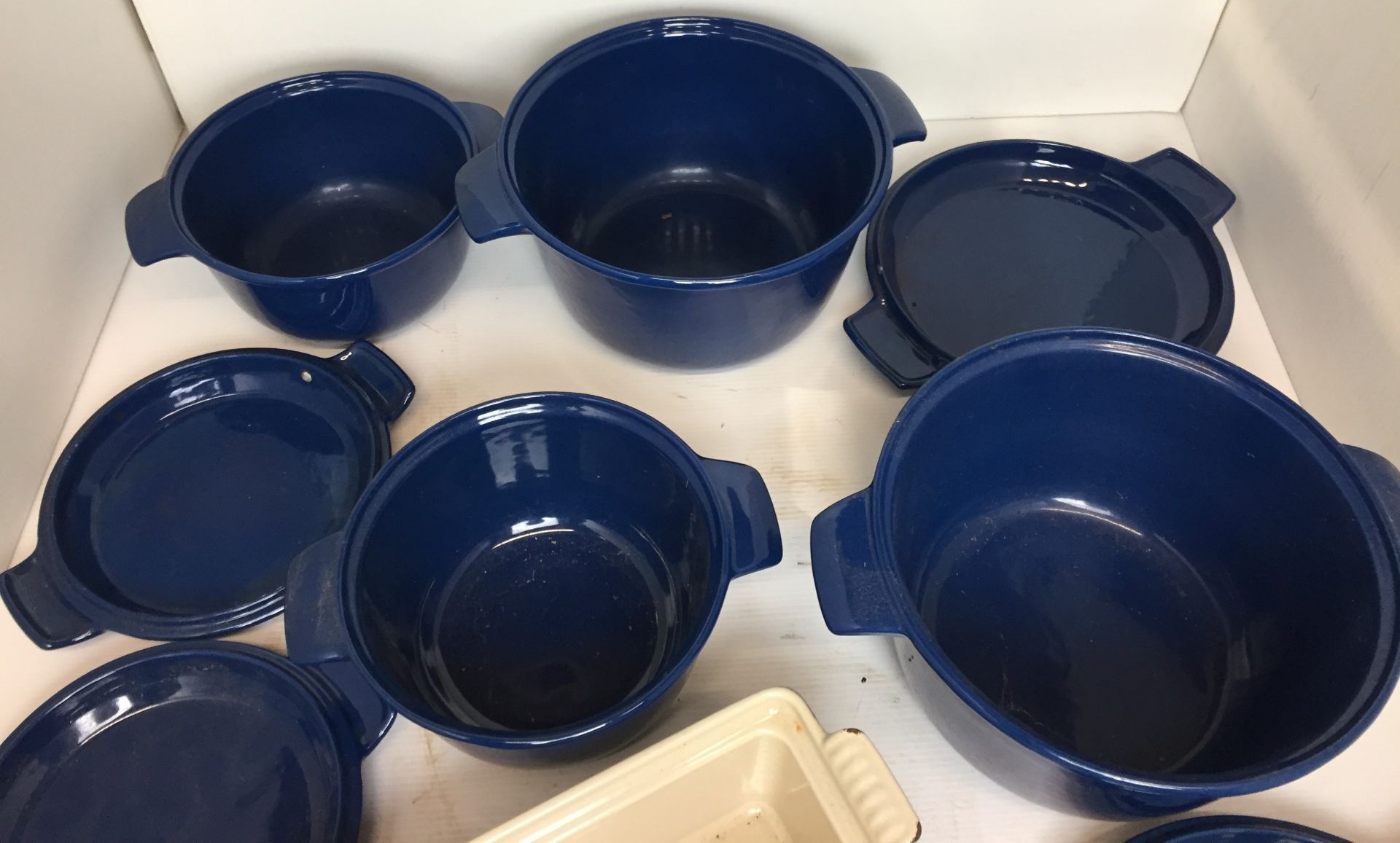 Five pieces of blue enamel cast iron oven to table ware including four ...