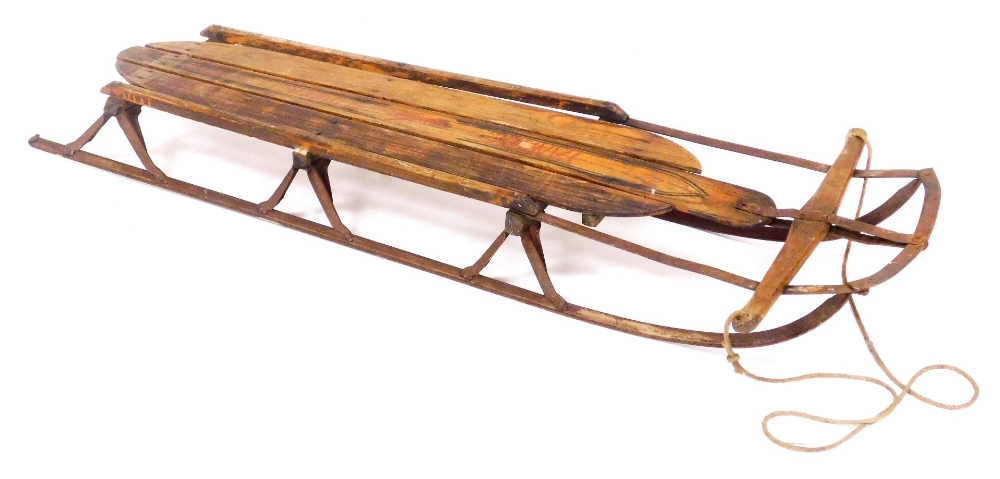 A Yankee Clipper wooden and cast iron bobsleigh, 141cm wide.