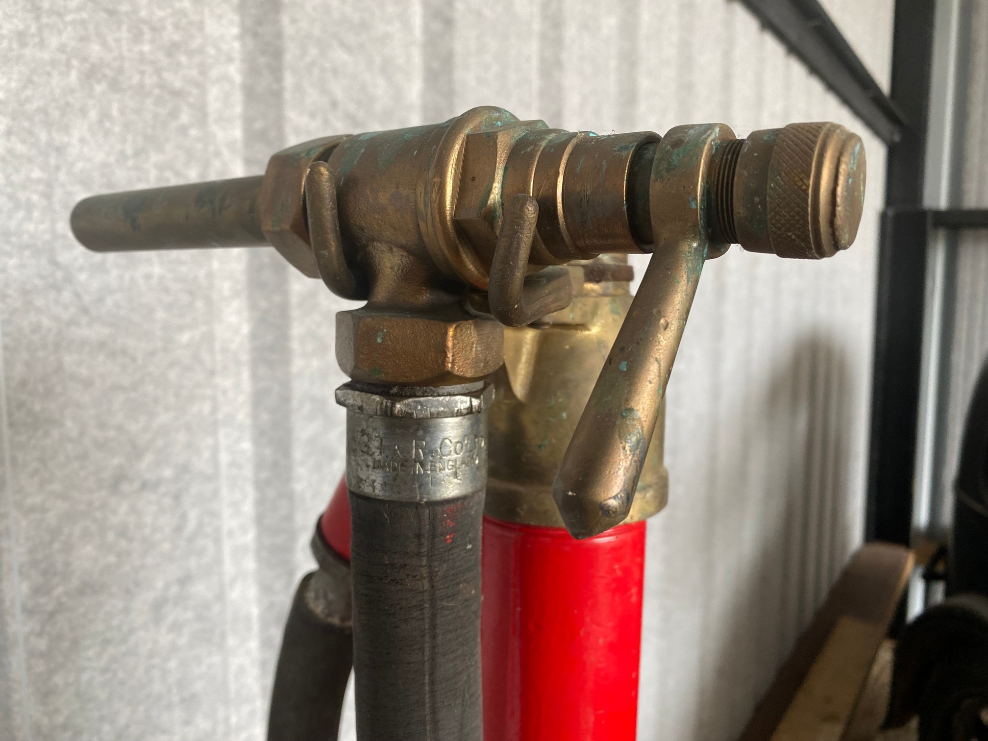 An Avery Hardoll CH1 petrol pump with rubber hose and bronze nozzle ...