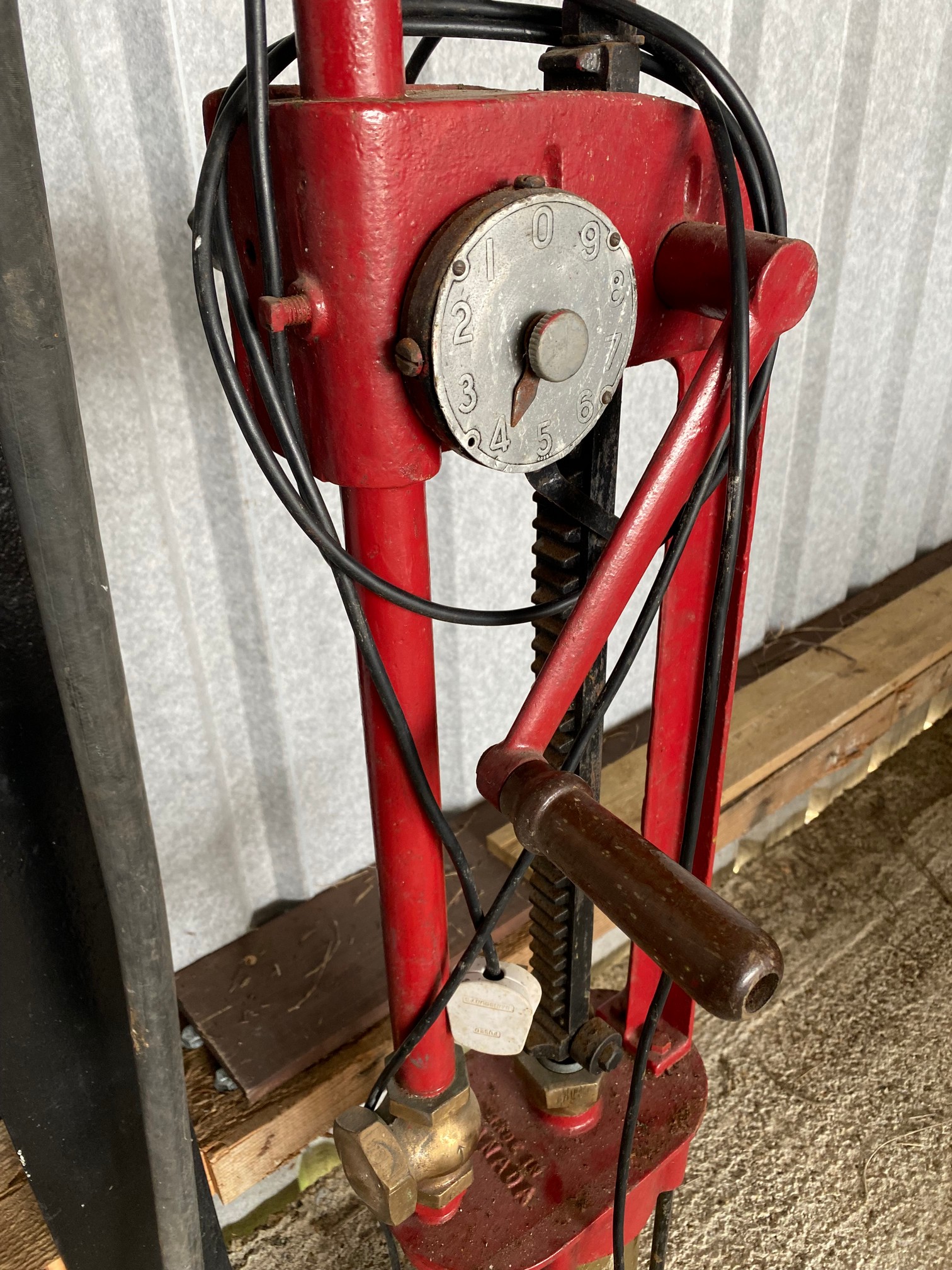 A Canadian skeleton petrol pump, probably a Wayne, with a rubber hose ...