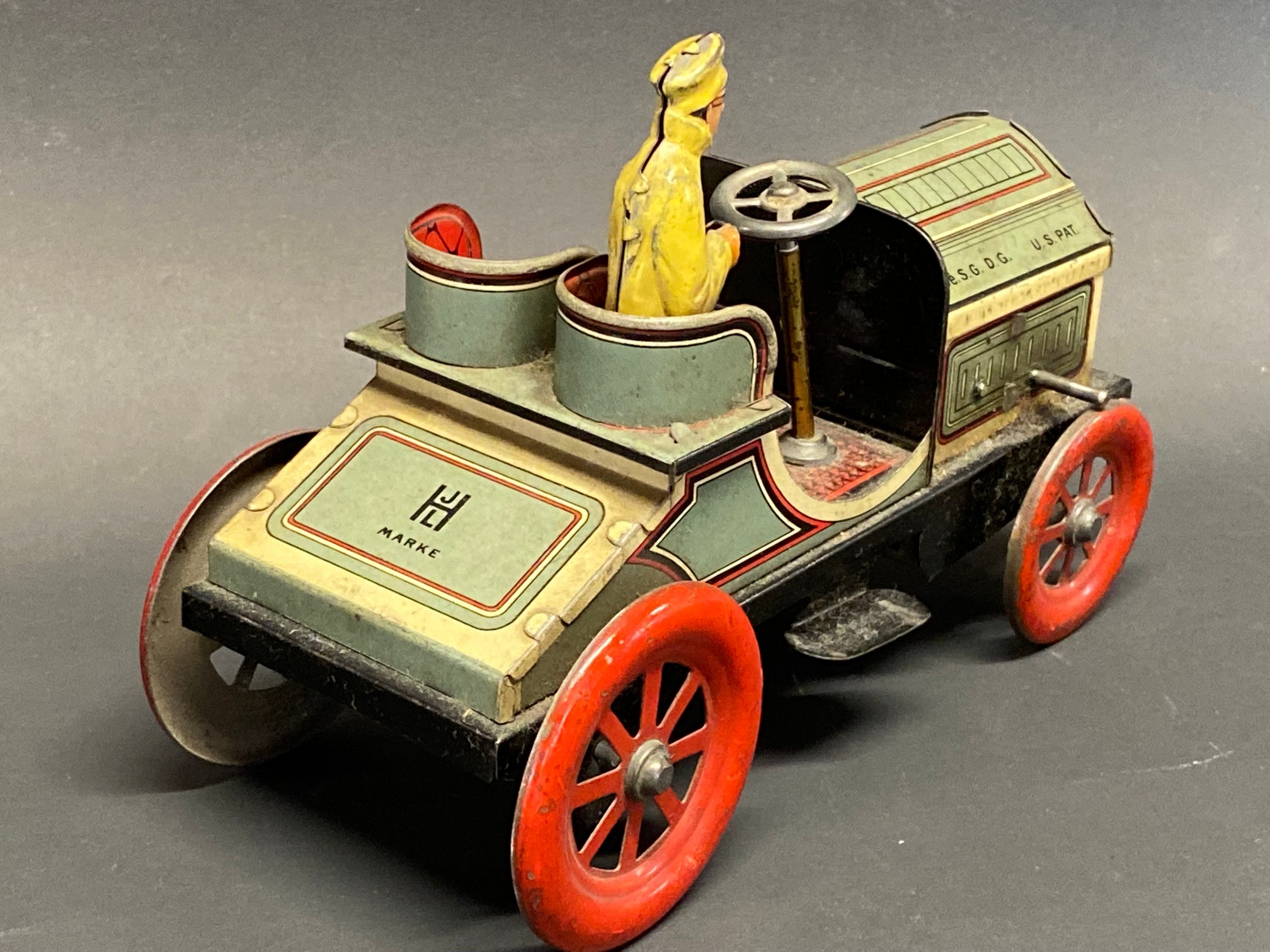 A superb German tinplate clockwork model of a veteran motor car by ...