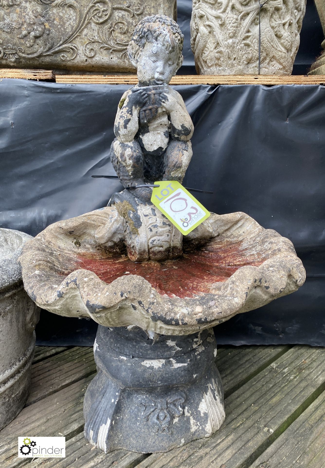 A reconstituted stone Bird Bath, with young Pan seated playing the ...