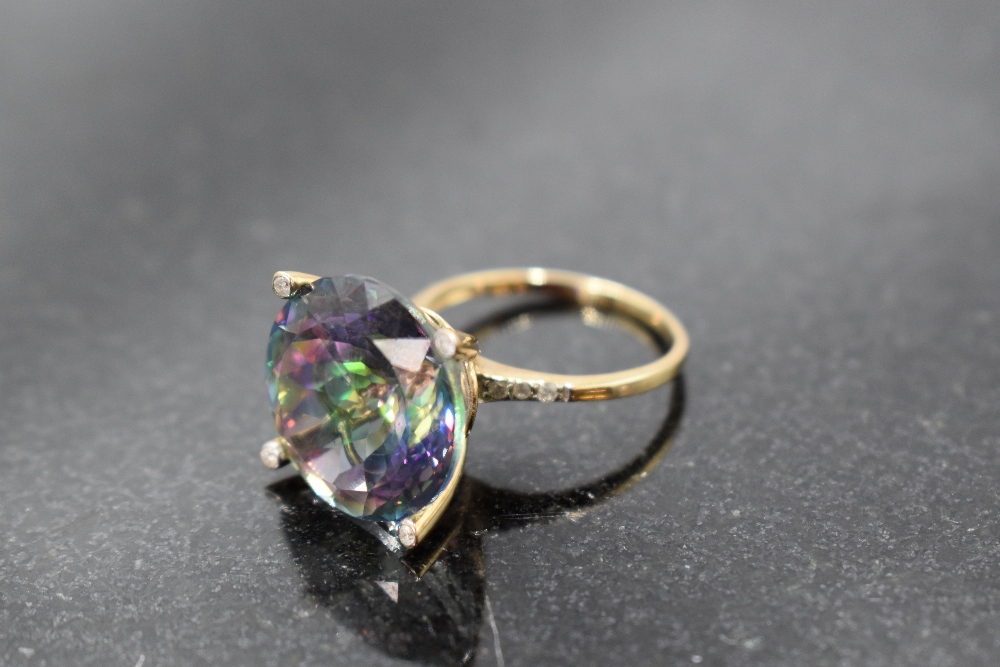 An oversized mystic topaz solitaire ring in a raised 4 claw mount to ...