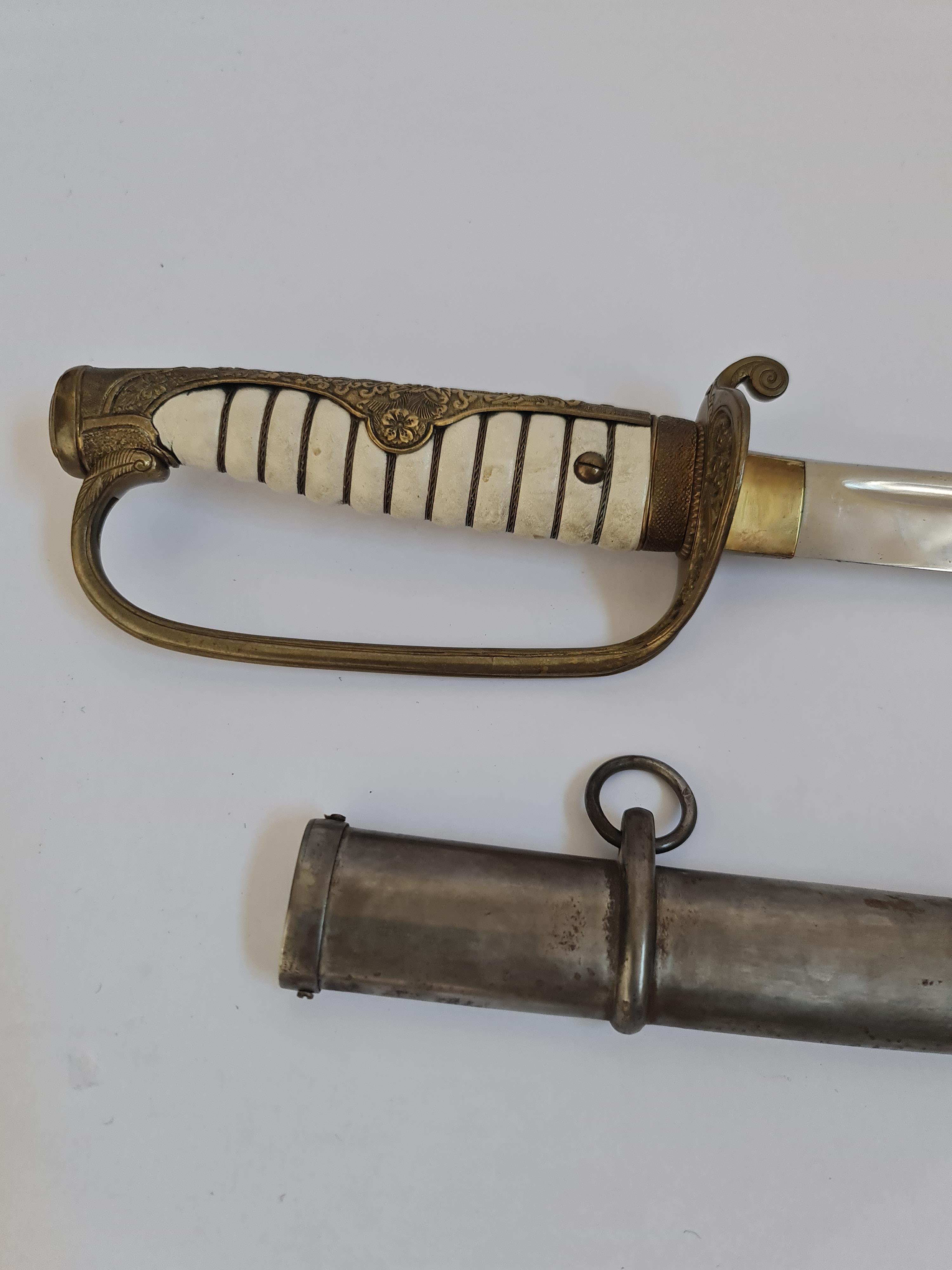 A WW2 Japanese Russo sword with brass D-guard and metal scabbard.