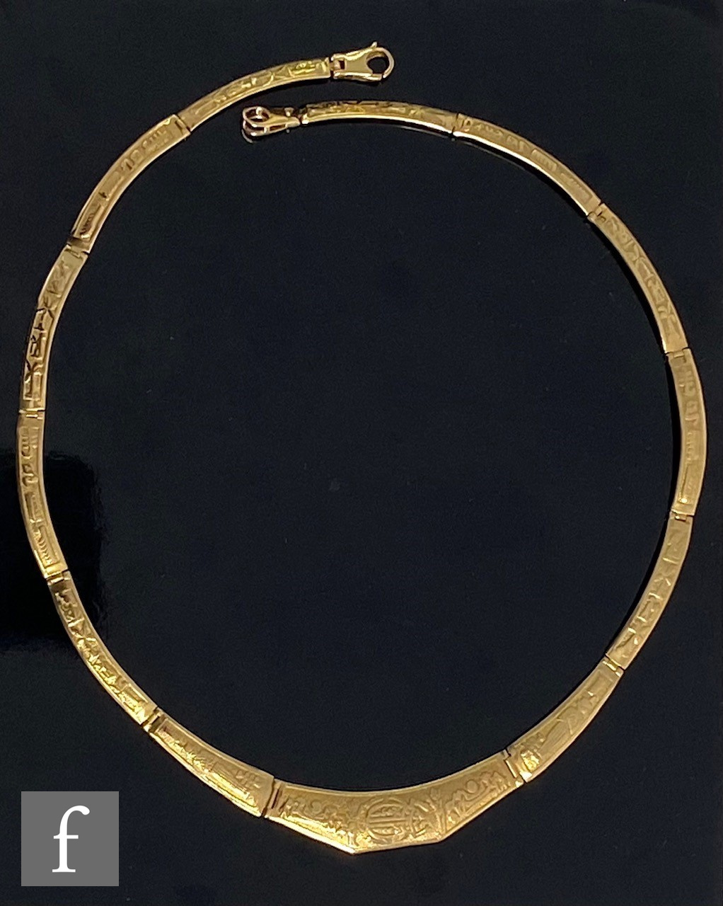 A 9ct hallmarked stiff collarette in the Egyptian taste comprising ...