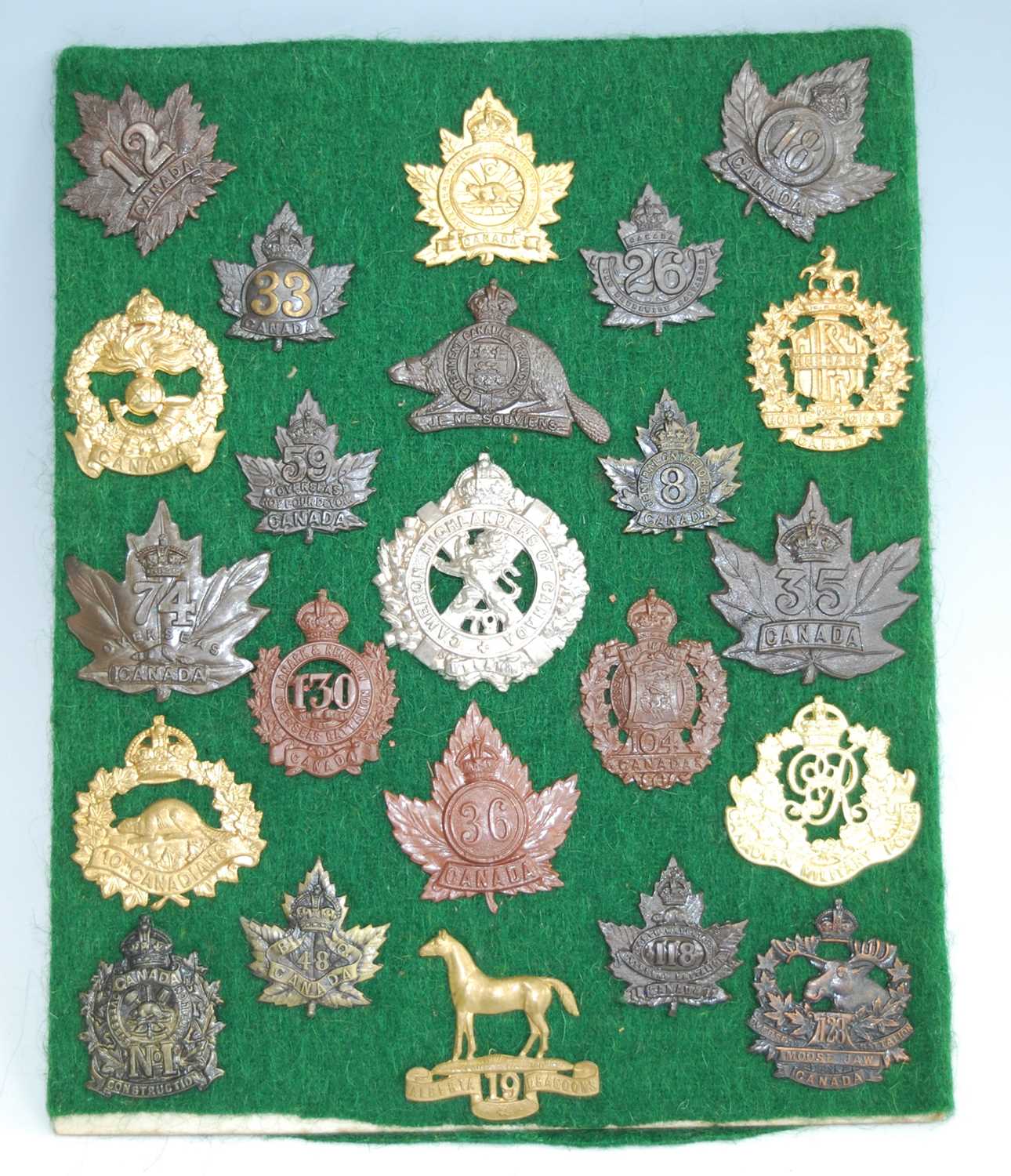 A collection of cap badges and insignia, being Canadian Regiments to ...
