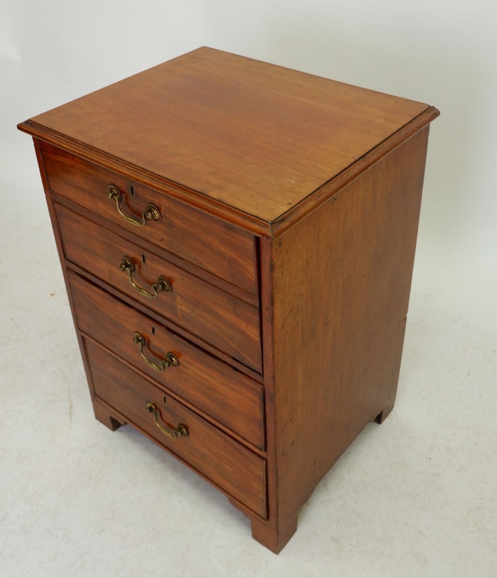 A Georgian mahogany night table with two hinged dummy drawers over two ...