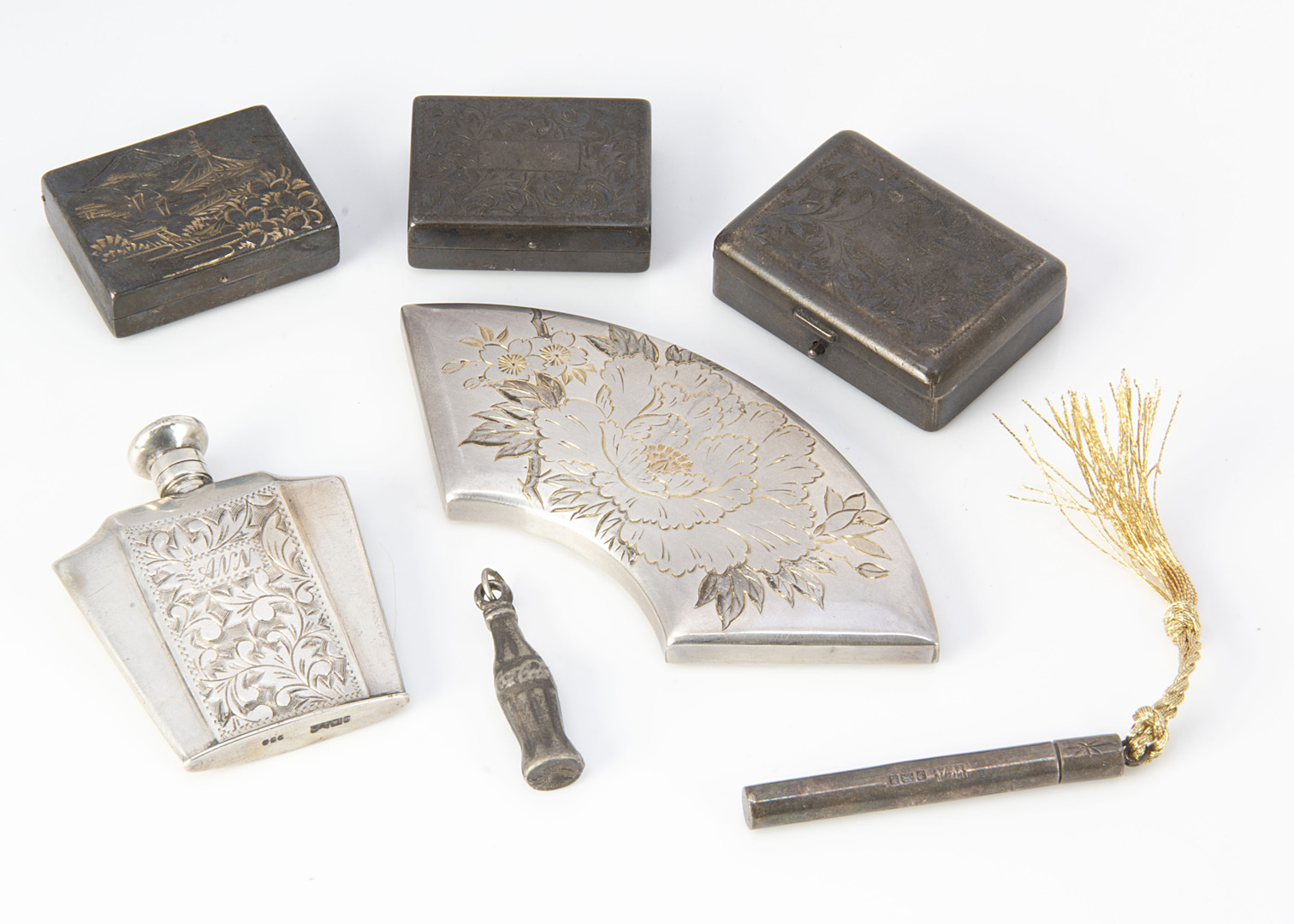 Three small Japanese white metal pill boxes, together with a needle ...