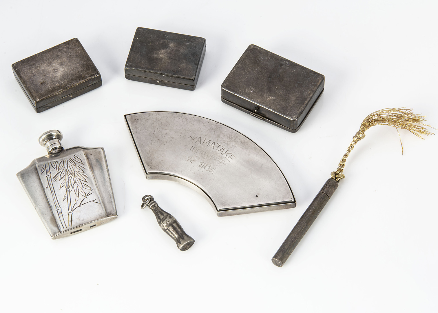 Three small Japanese white metal pill boxes, together with a needle ...