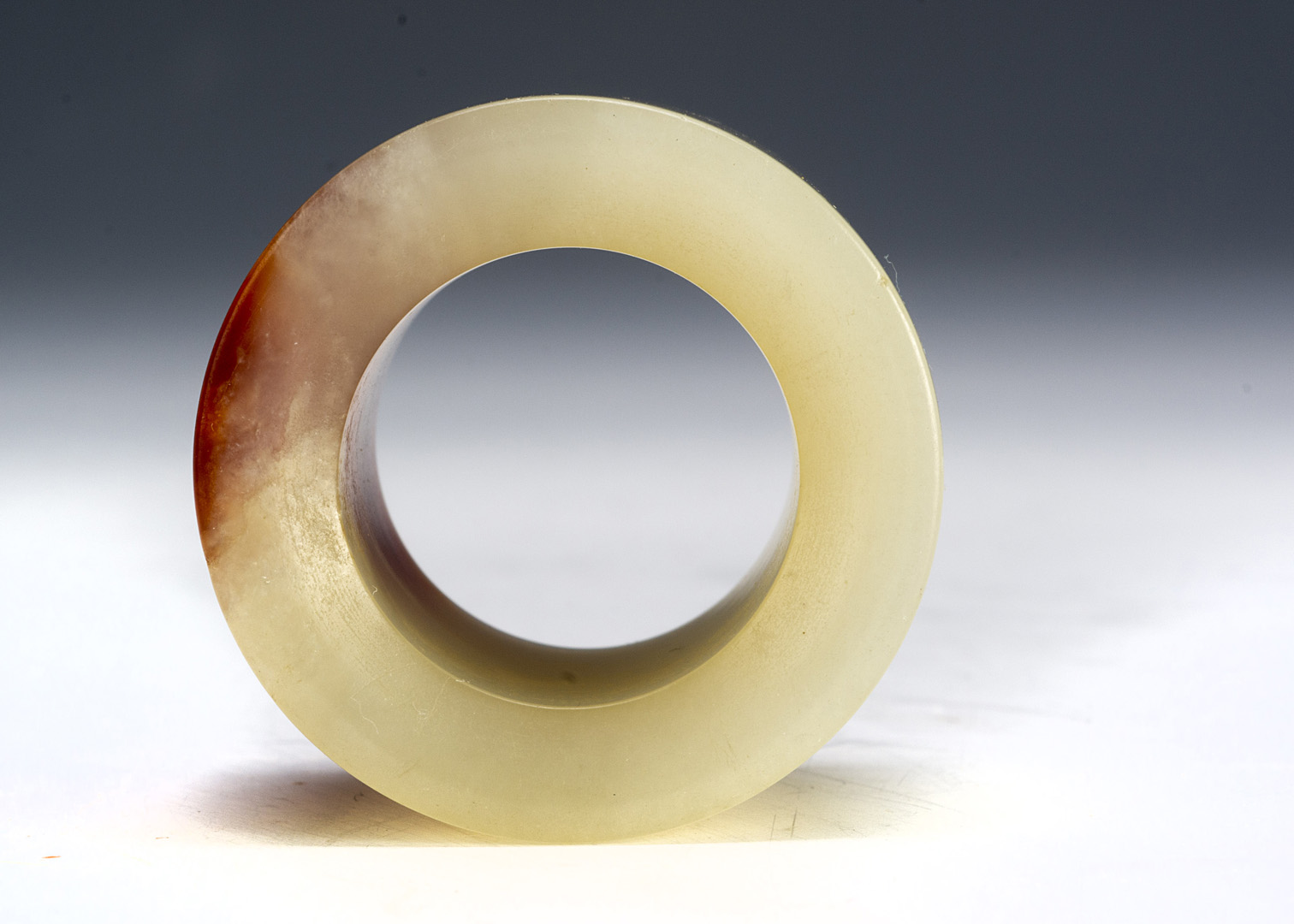 A 19th century Chinese Jadeite Jade archers ring. with iron inclusion ...