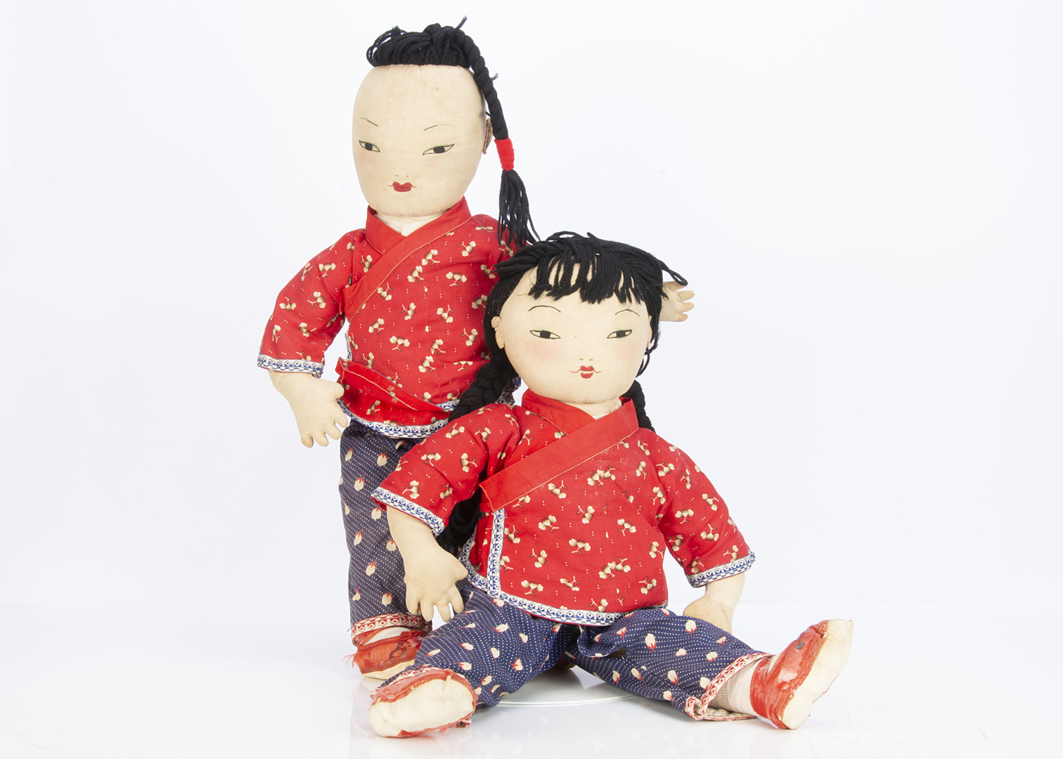 Two large Chinese cloth dolls, a boy and girl with embroidered faces ...