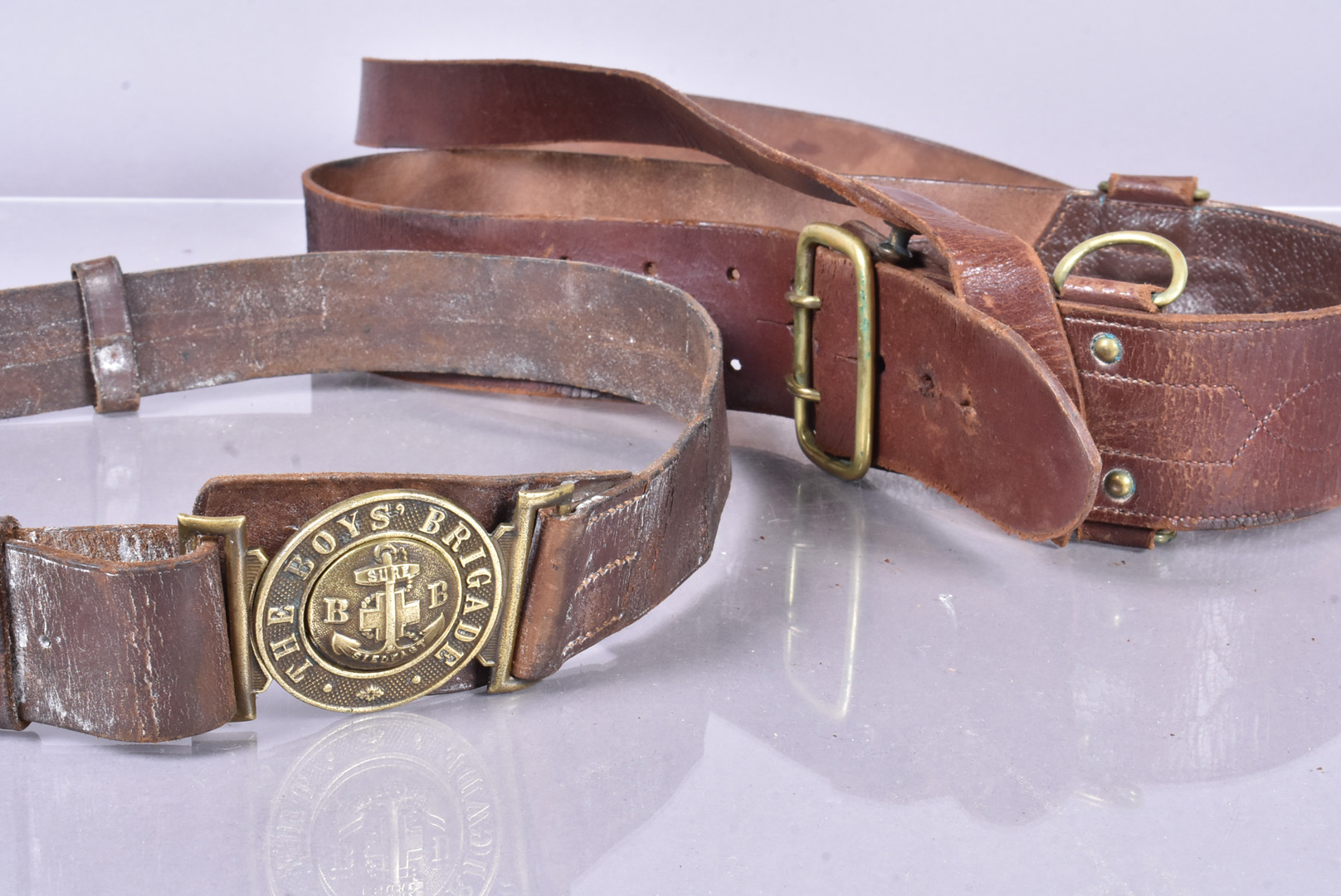 A brown leather Boys Brigade belt, together with a Sam Browne belt (2)