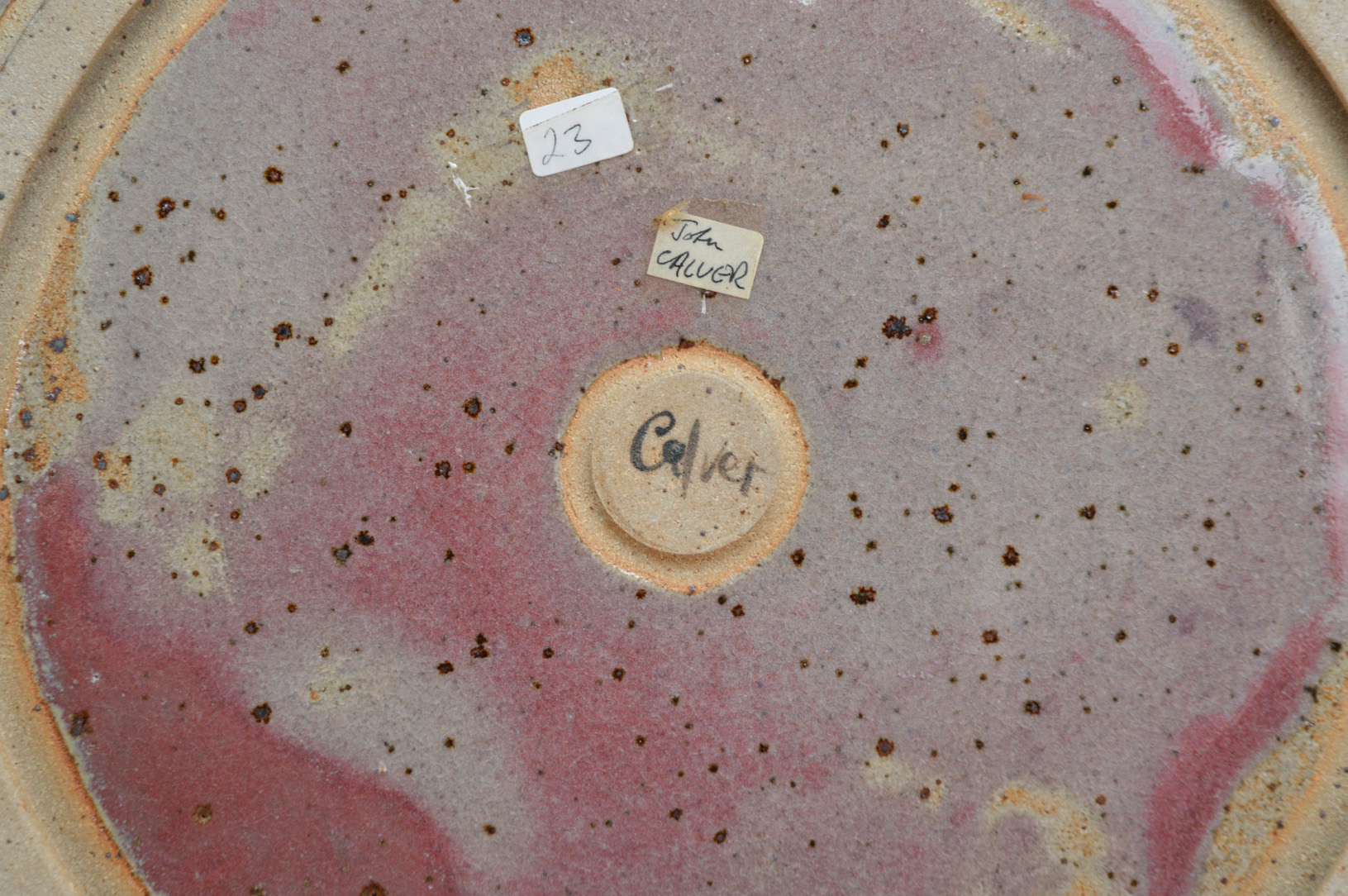A large stoneware charger by John Calver, foliate and floral design ...
