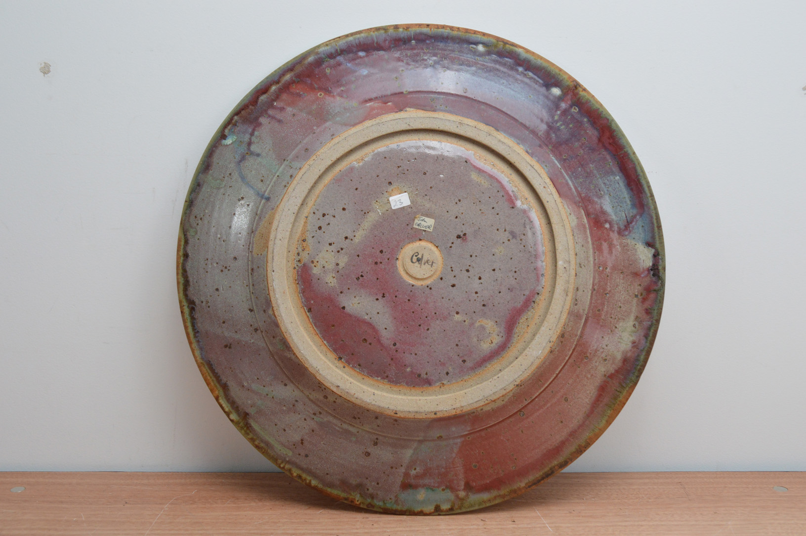 A large stoneware charger by John Calver, foliate and floral design ...