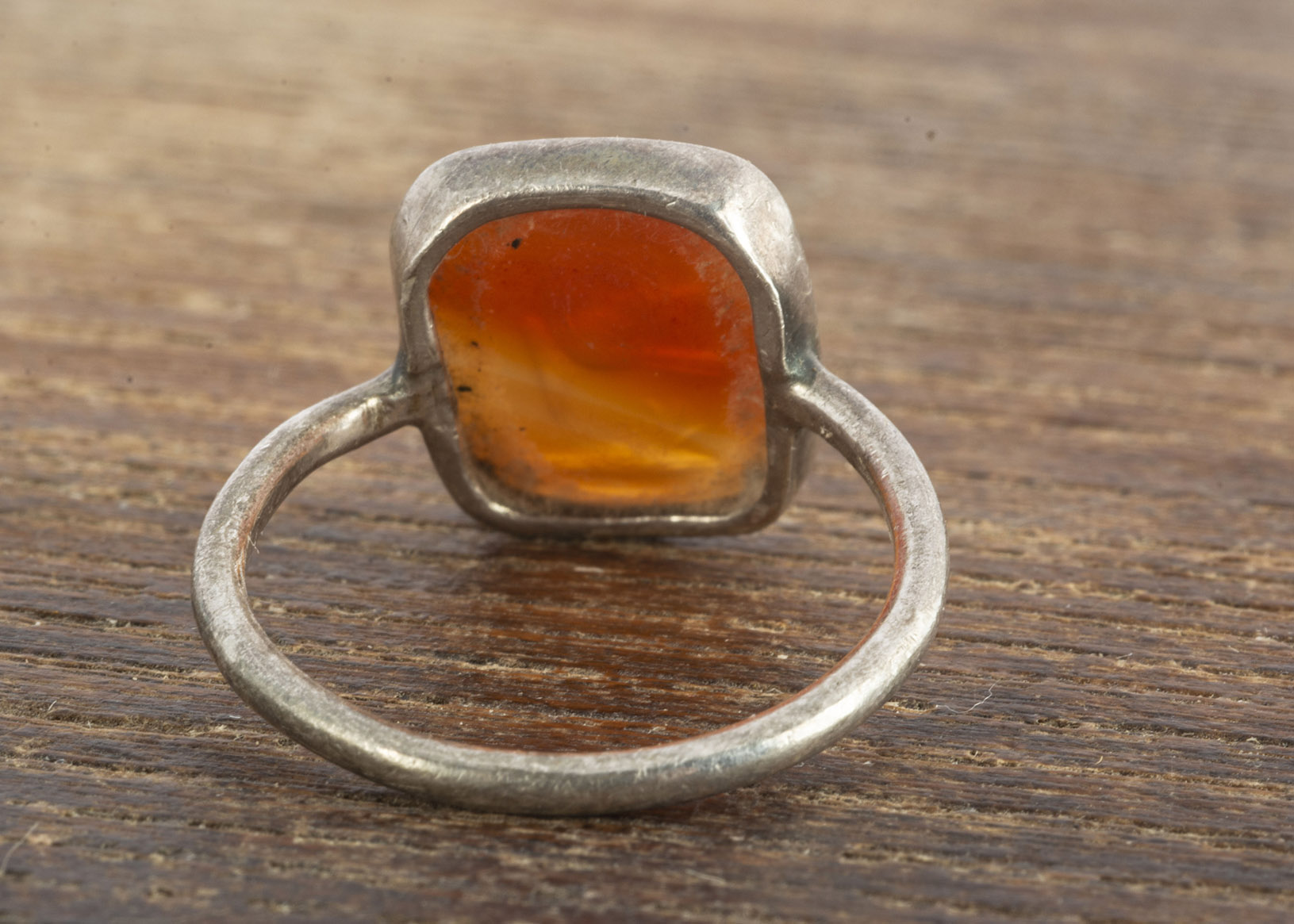 A 19th Century carnelian silver set signet ring, with intaglio carving ...