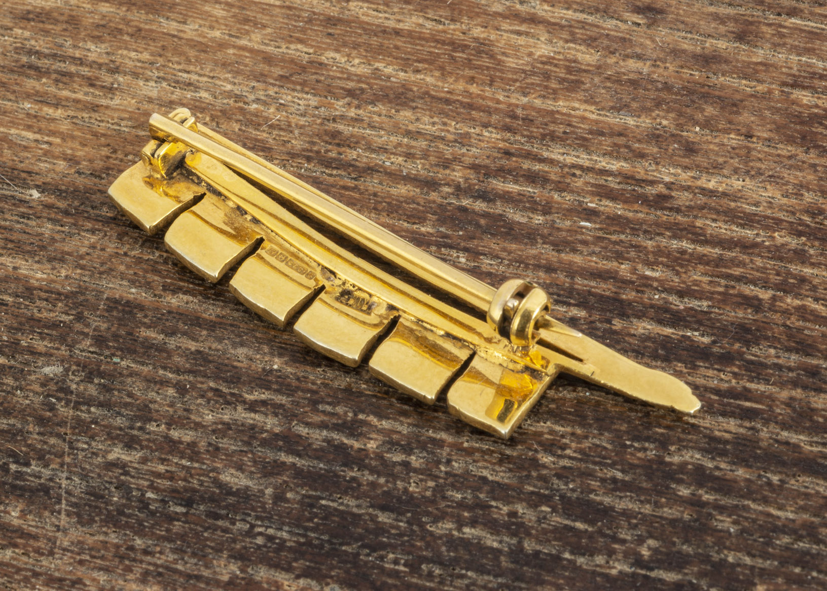 A 9ct gold enamel semaphore brooch spelling Eileen, 4.1cm, 4.8g