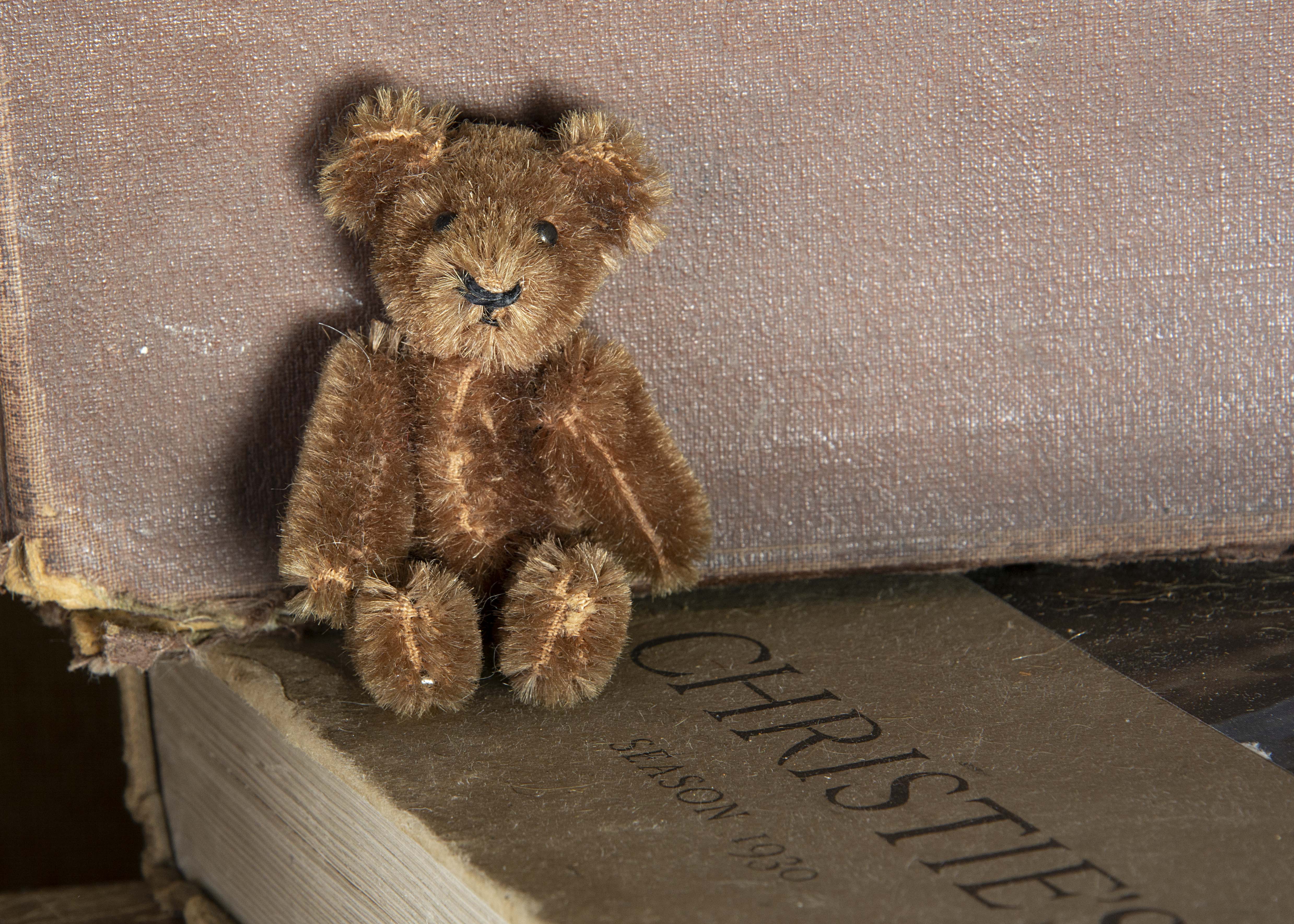 A post-war Schuco miniature Teddy Bear, with brown mohair, black pin ...