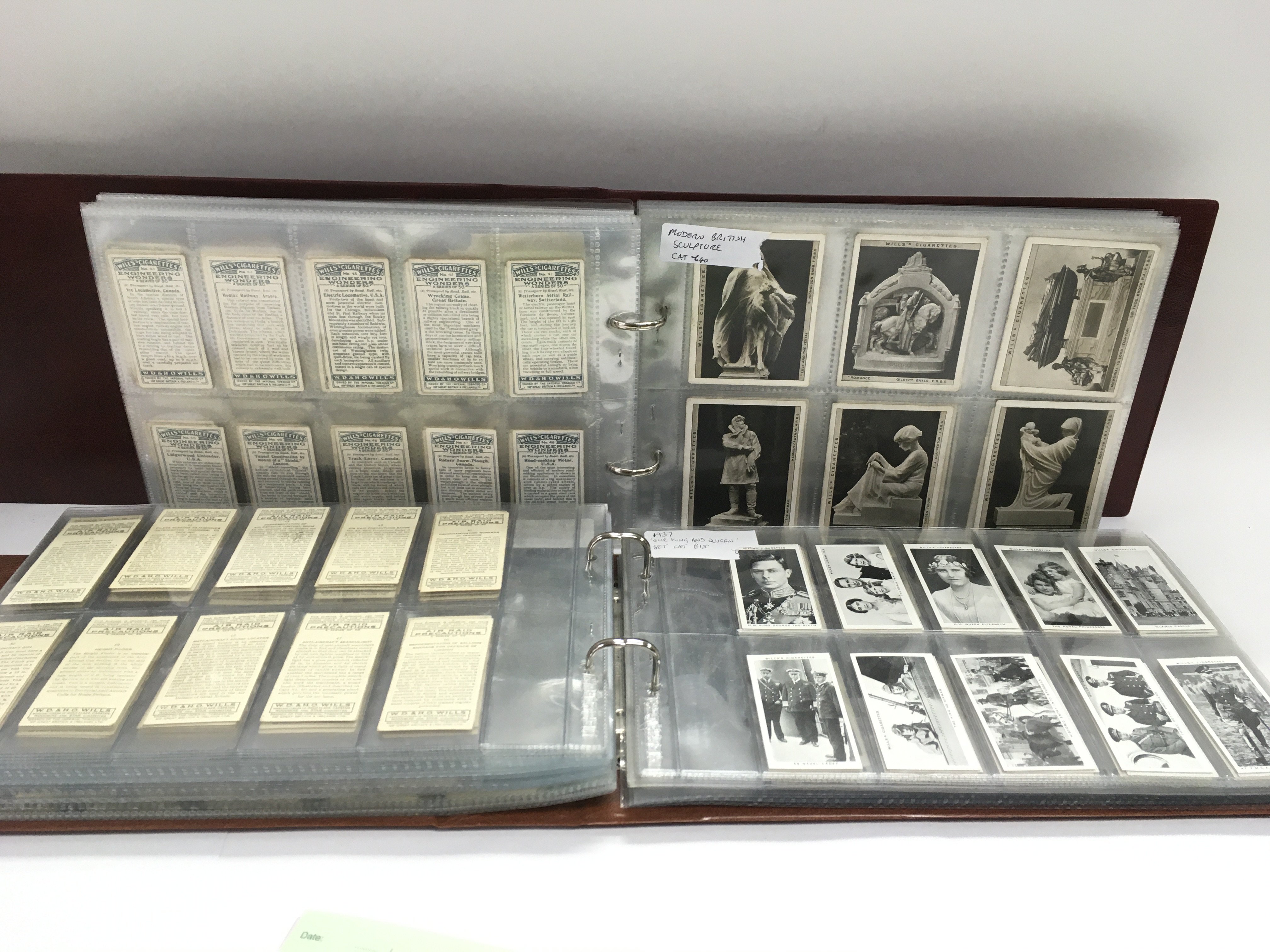 A collection of cigarette card sets in two albums.
