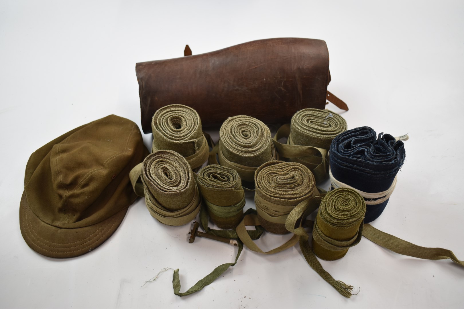 WW2 Japanese cloth cap, leather gaiters, canvas strap and eight puttees