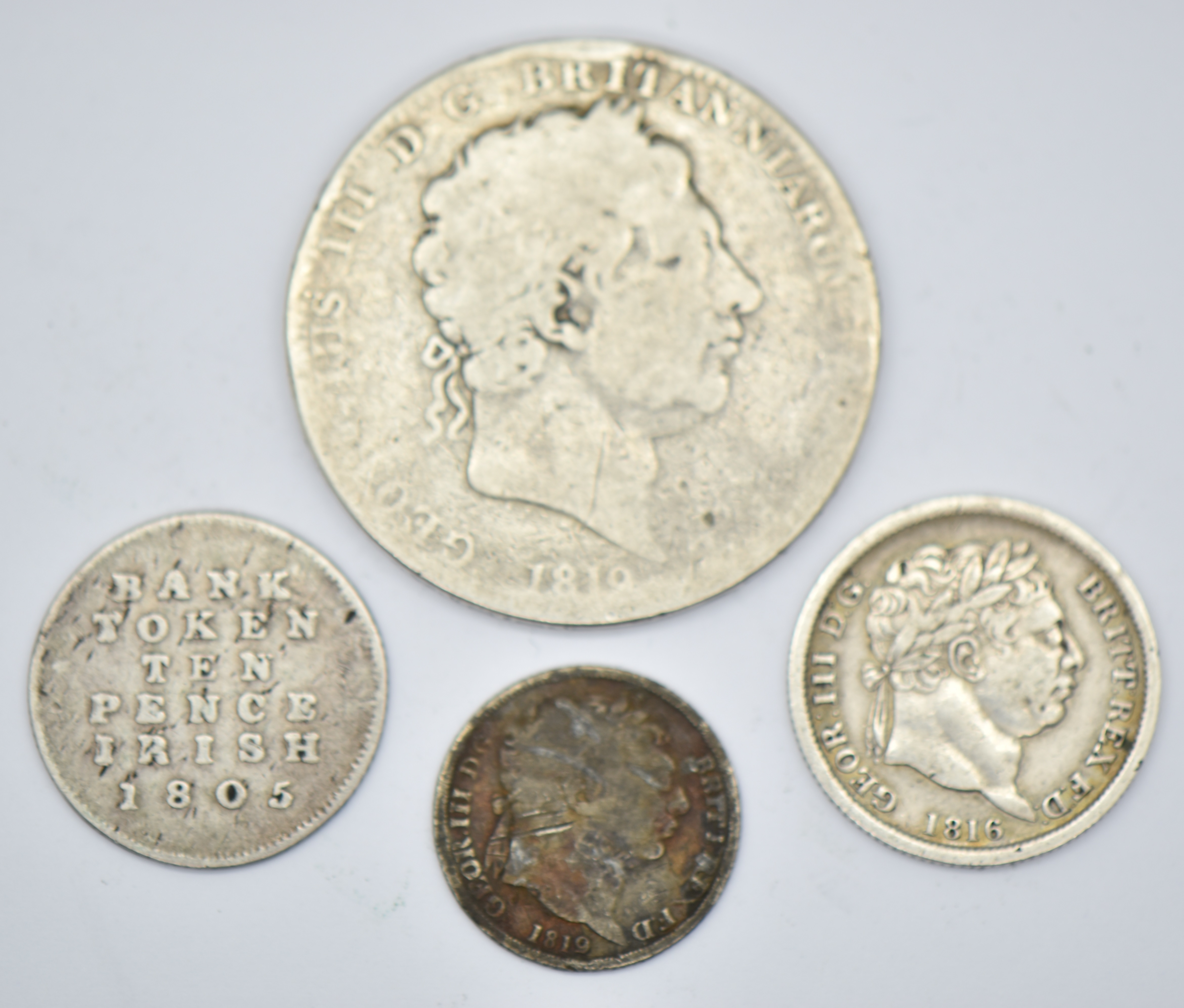 Four George III coins comprising 1819 crown, 1816 bull head shilling ...