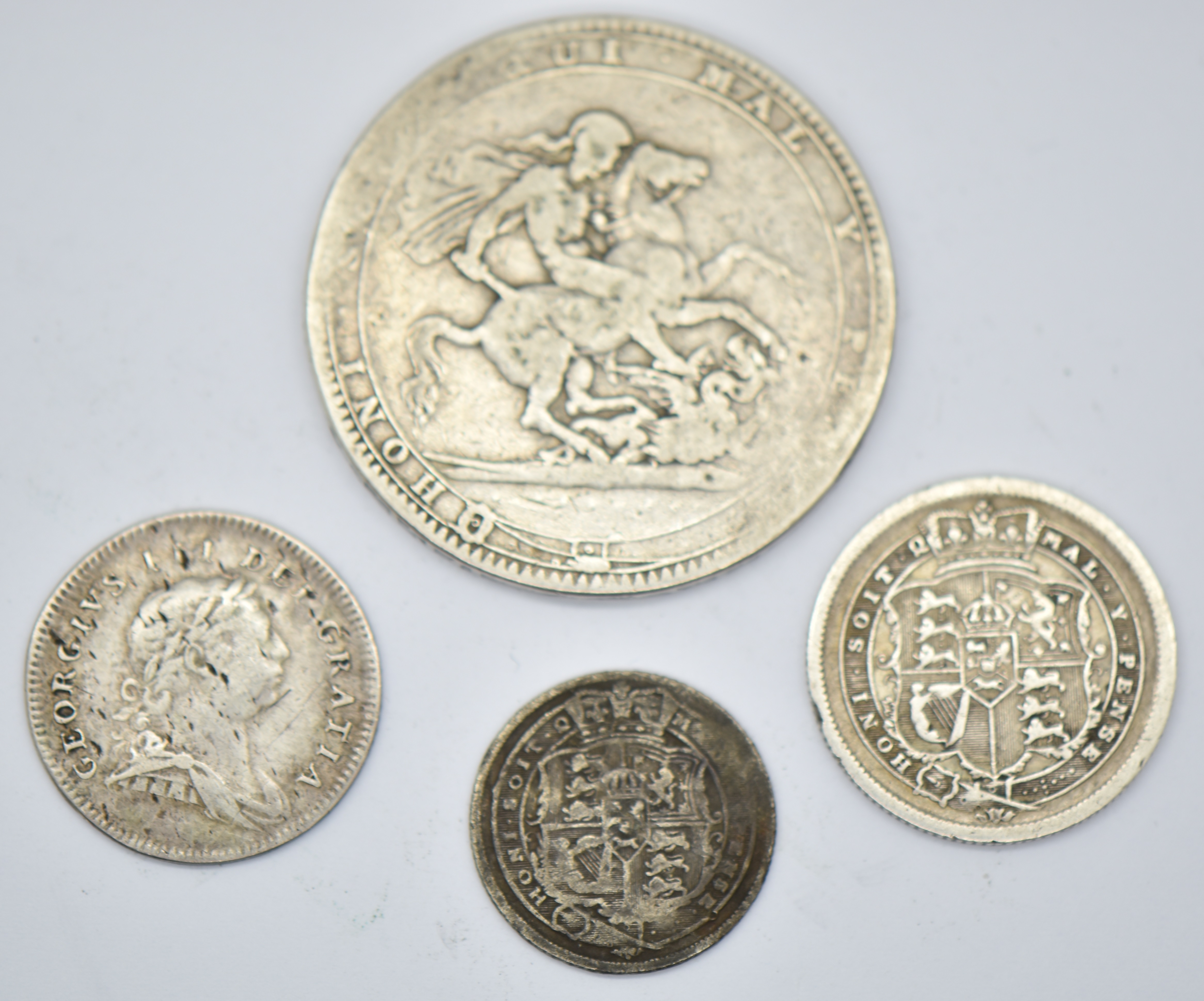 Four George III coins comprising 1819 crown, 1816 bull head shilling ...