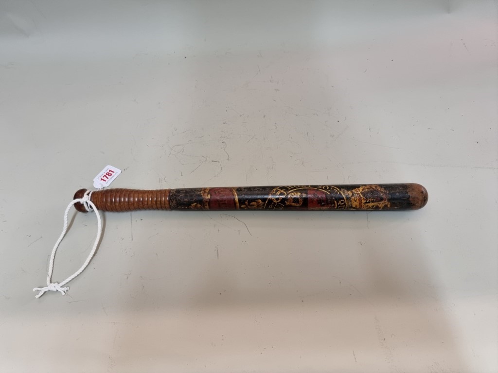 A 19th century painted wood police truncheon, 47cm.