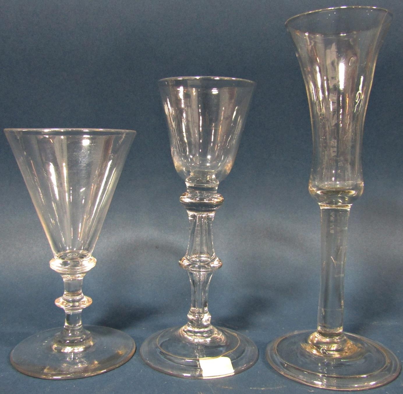 Four Georgian solid stemmed wine glasses of varying design , a flared ...