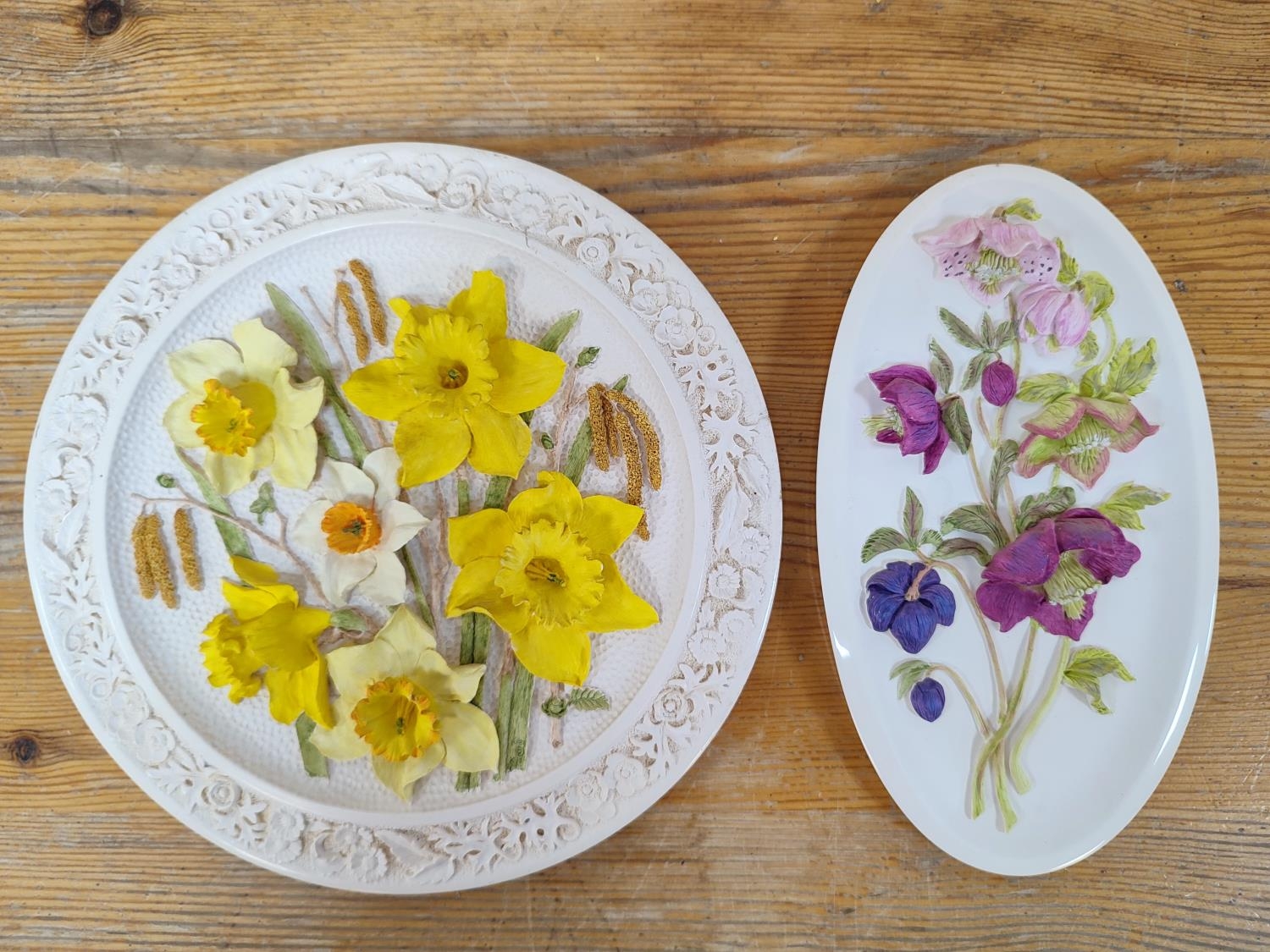 Watersmeet, two hand-painted ceramic floral hanging wall plaques (2)