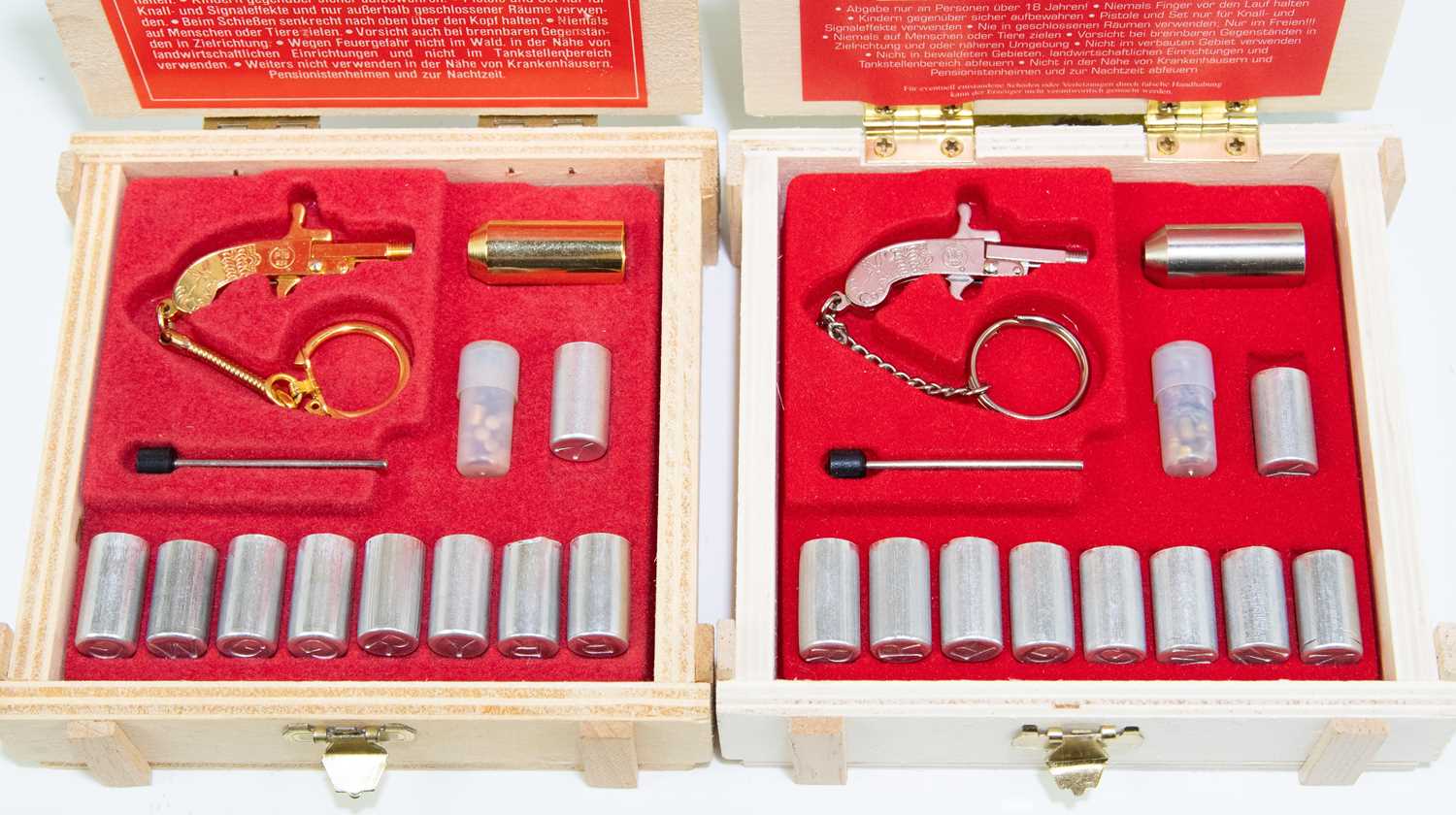 BERLOQUE PISTOLE; two cased miniature pin fire pistols, with flare ...