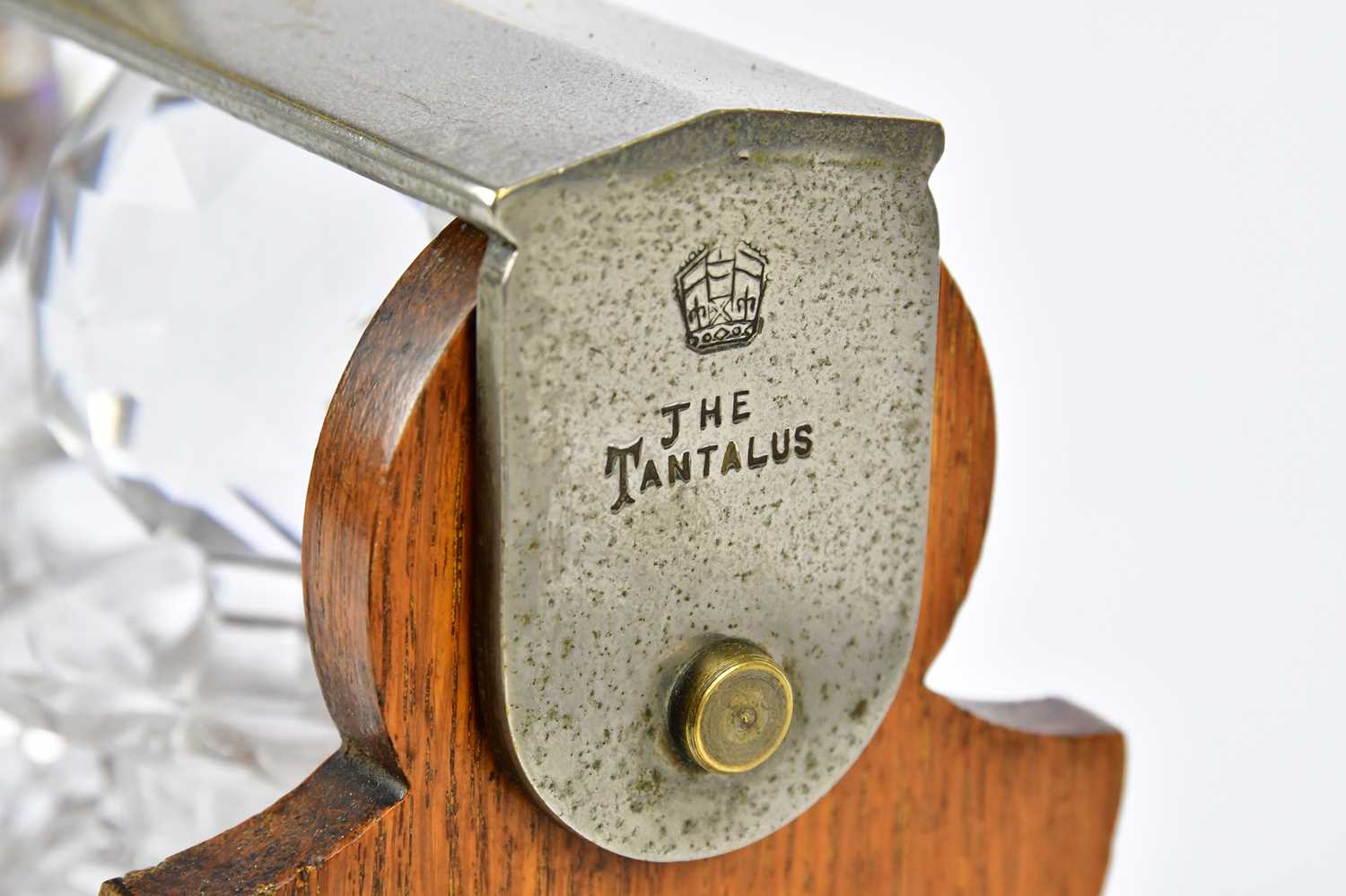 An Edwardian oak three section tantalus, stamped "Betjemanns, the ...