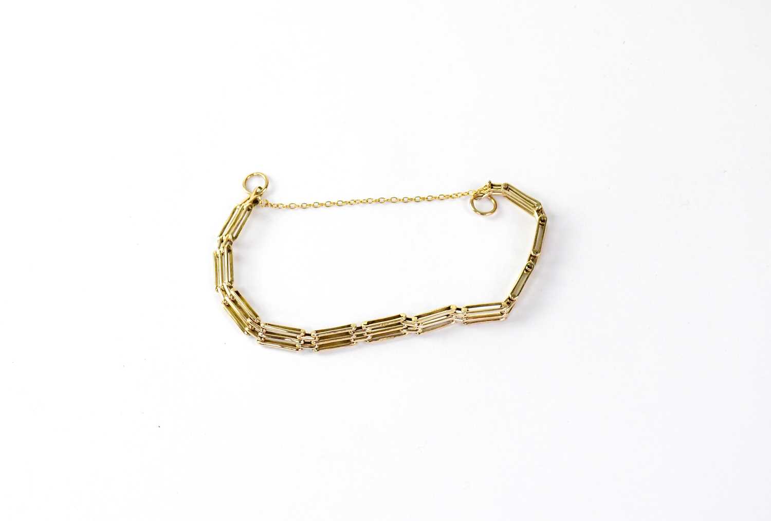 A 9ct gold three bar gate bracelet with safety chain, stamped 375 ...