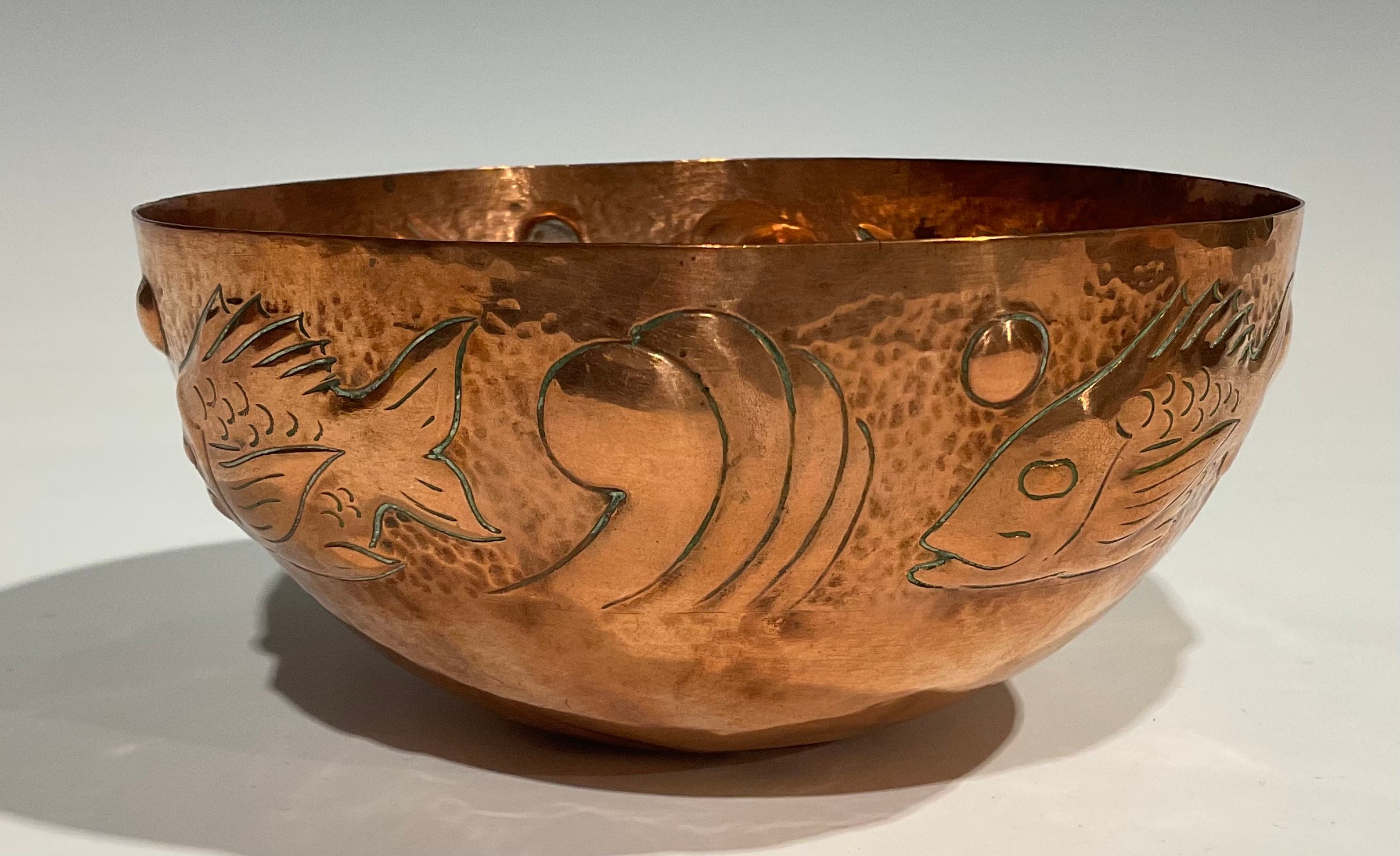 A Newlyn Arts & Crafts copper bowl, repousse embossed with a repetitive ...