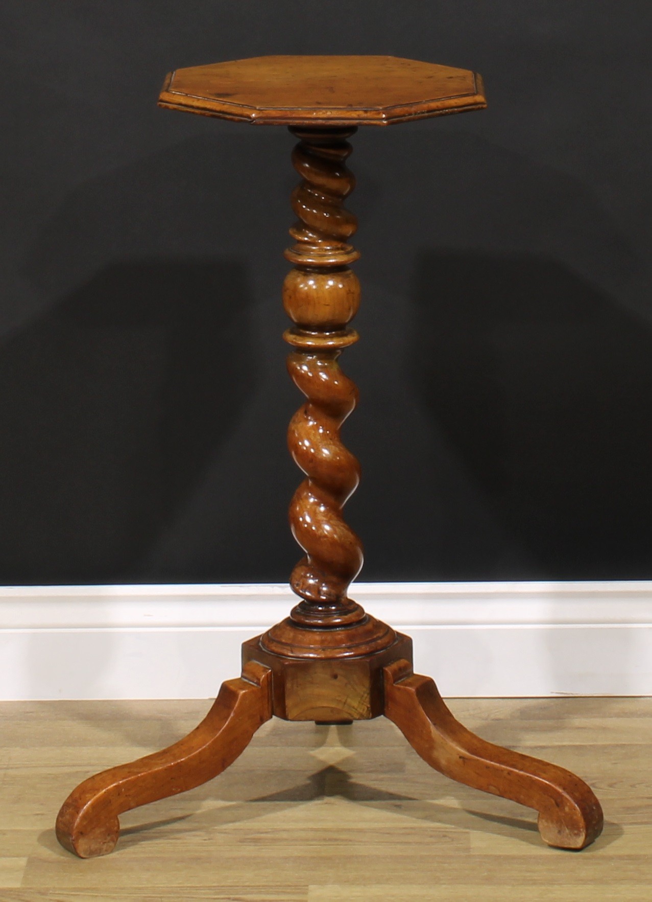 A William & Mary walnut tripod candle stand, octagonal top, spiral-and ...