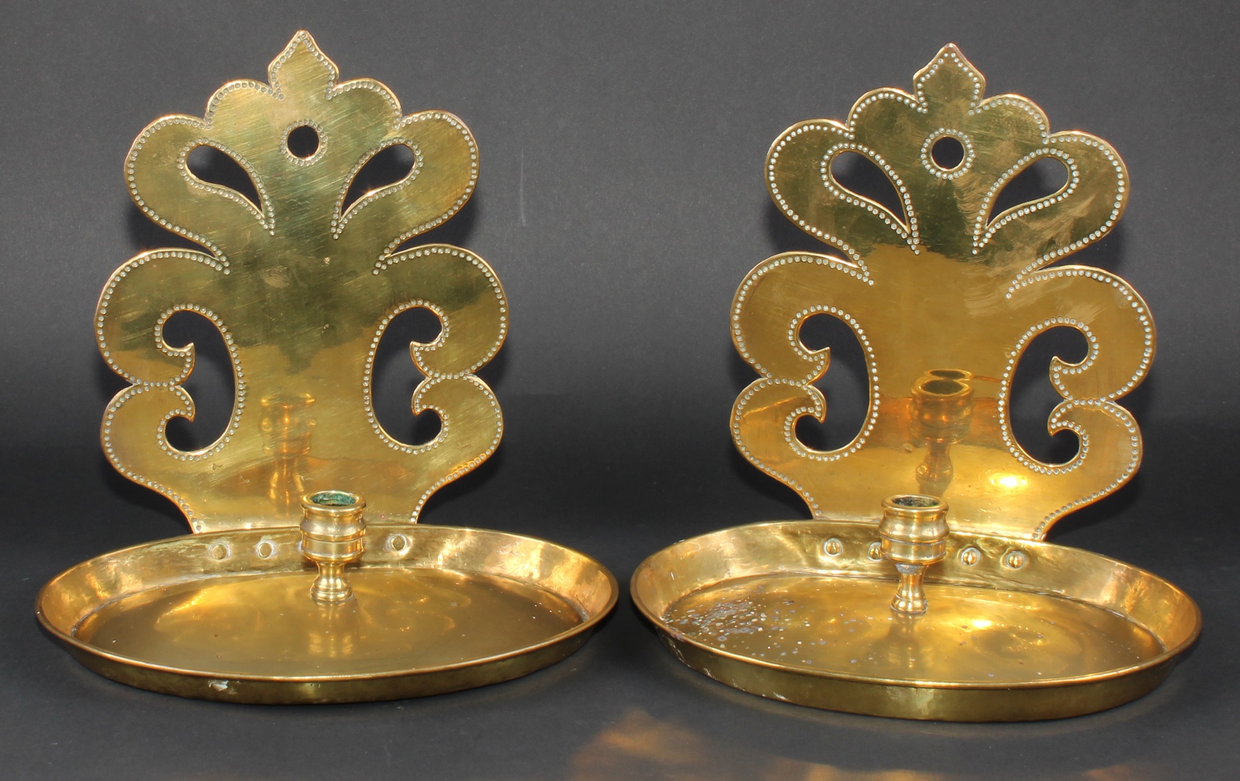 A pair of 18th century Dutch brass wall sconces, each with a shaped ...