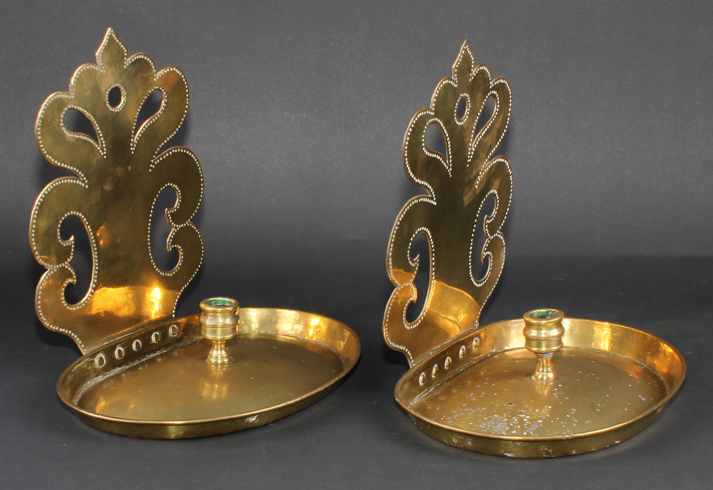 A pair of 18th century Dutch brass wall sconces, each with a shaped ...