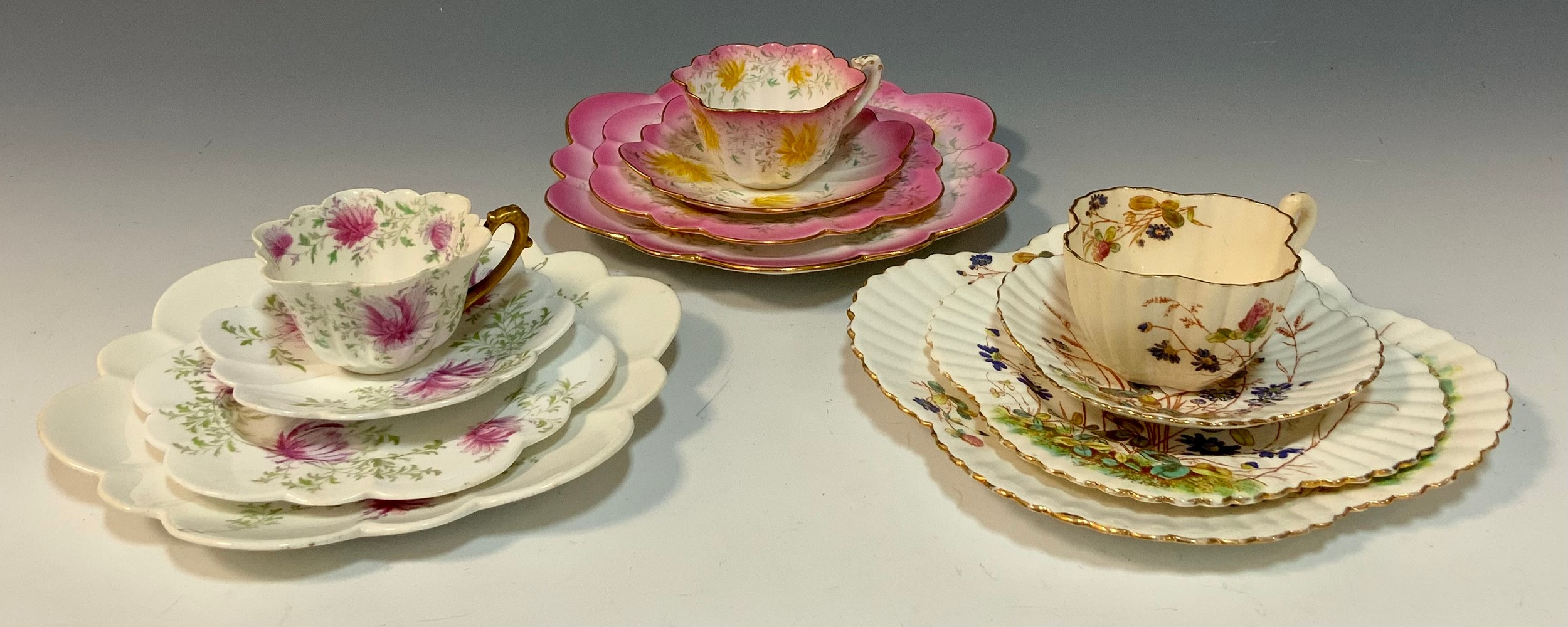 A group of three Wileman and Company tea trios including ...