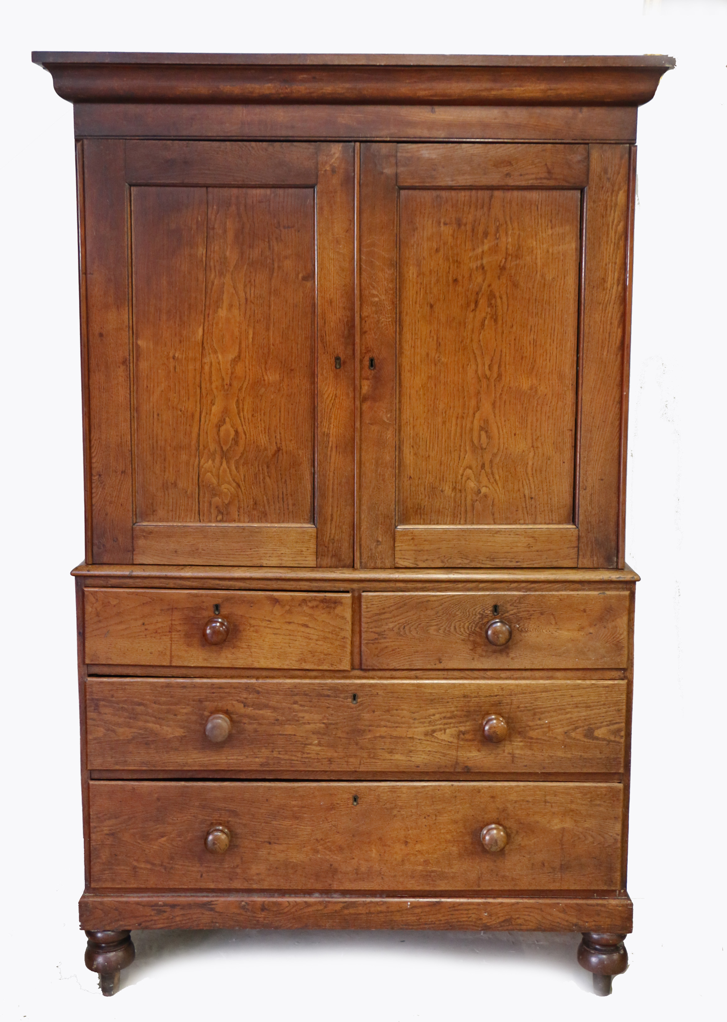 A Mid 19th century oak linen press, having a out swept cornice above a ...