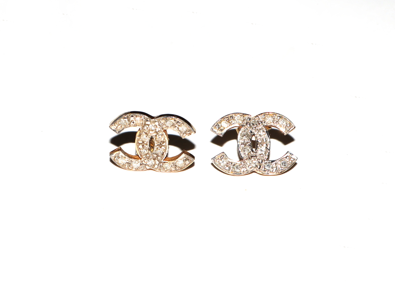 A pair of 18ct gold Chanel diamond set crossed C's shaped stud earrings ...