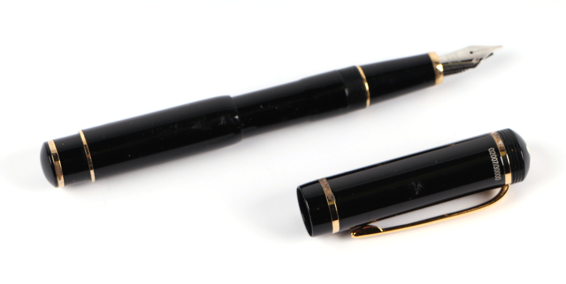 A black lacquer and gilt metal fountain pen with iridium point nib ...