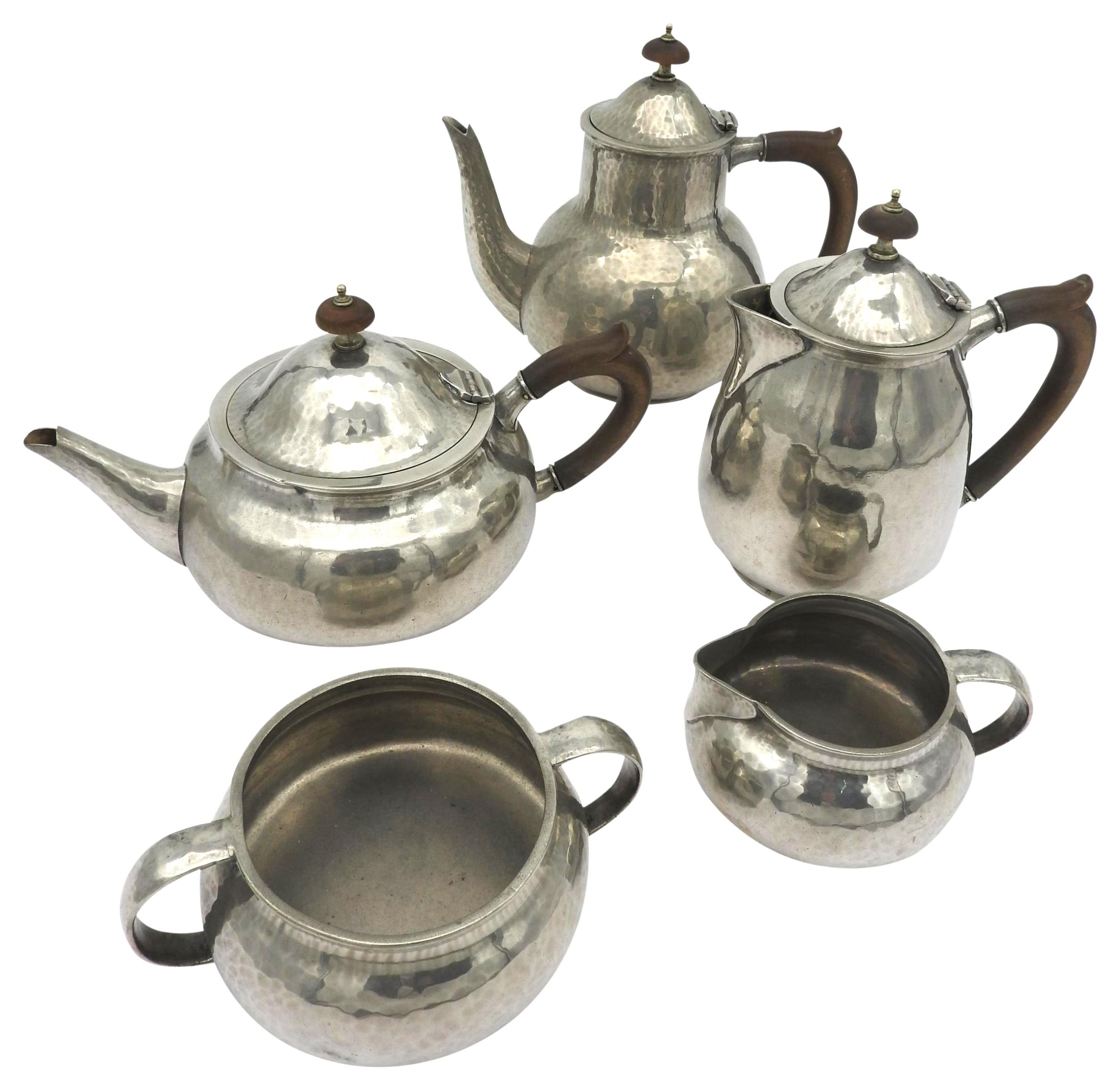 A LIBERTY FIVE PEWTER TEA SET with hammered finish marked 'Made by ...
