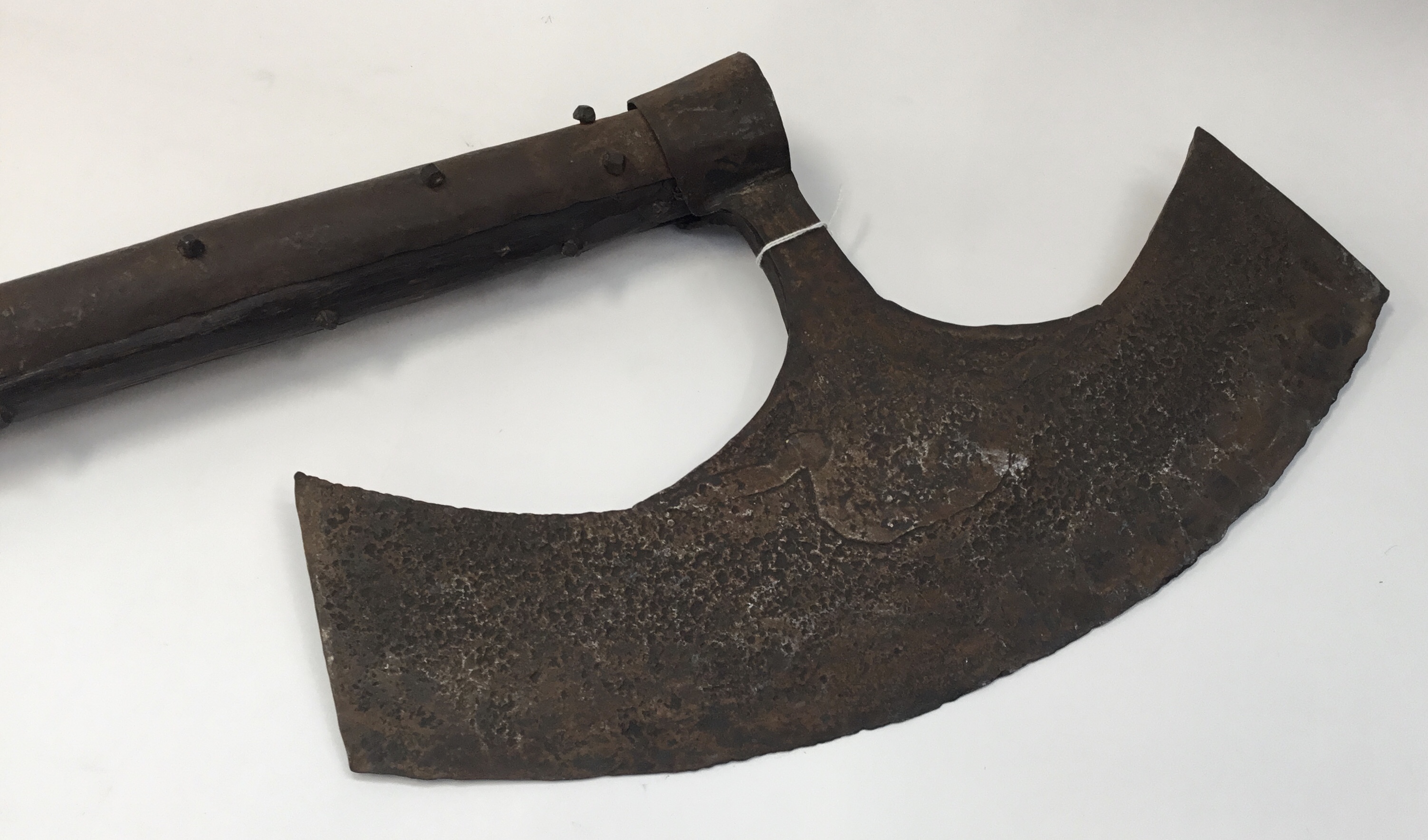 An unusual European 18th / 19th century bearded axe. Curved wooden haft ...