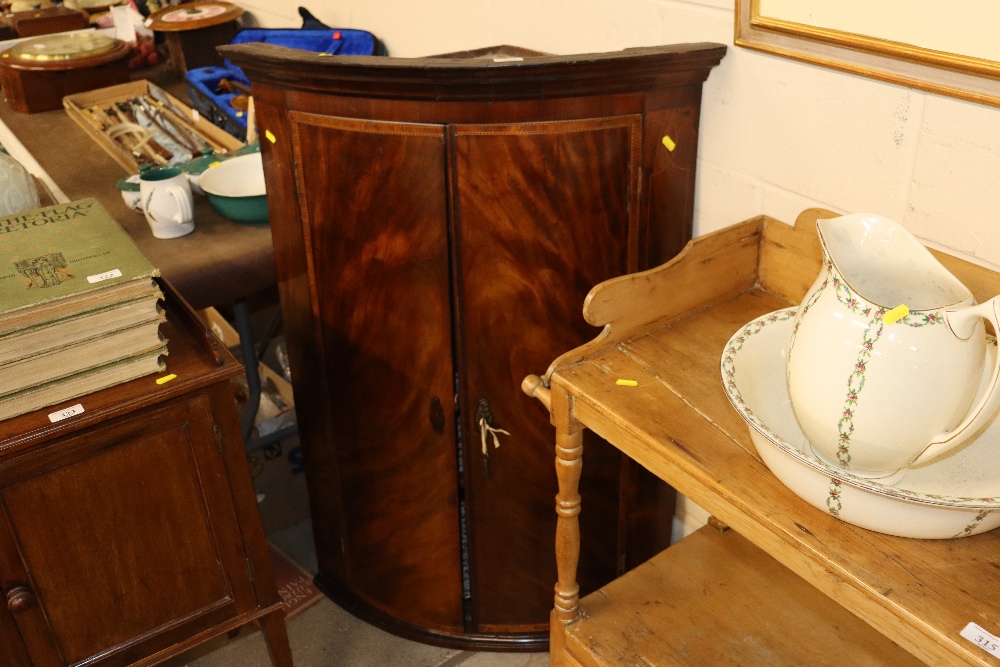 A 19th Century mahogany elliptical corner cupboard