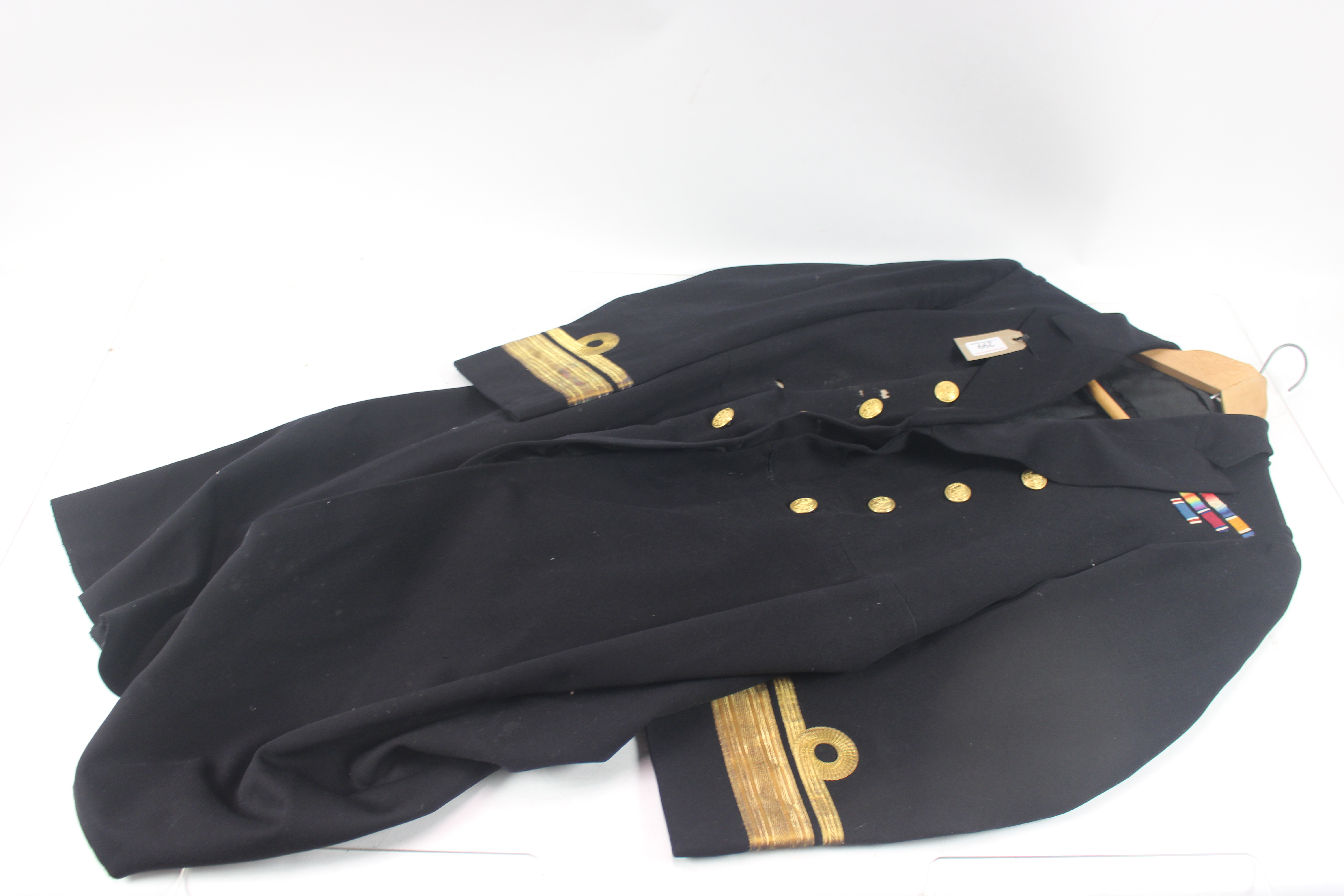 A Royal Navy Frock Coat with a Rear Admiral insignia together with his ...