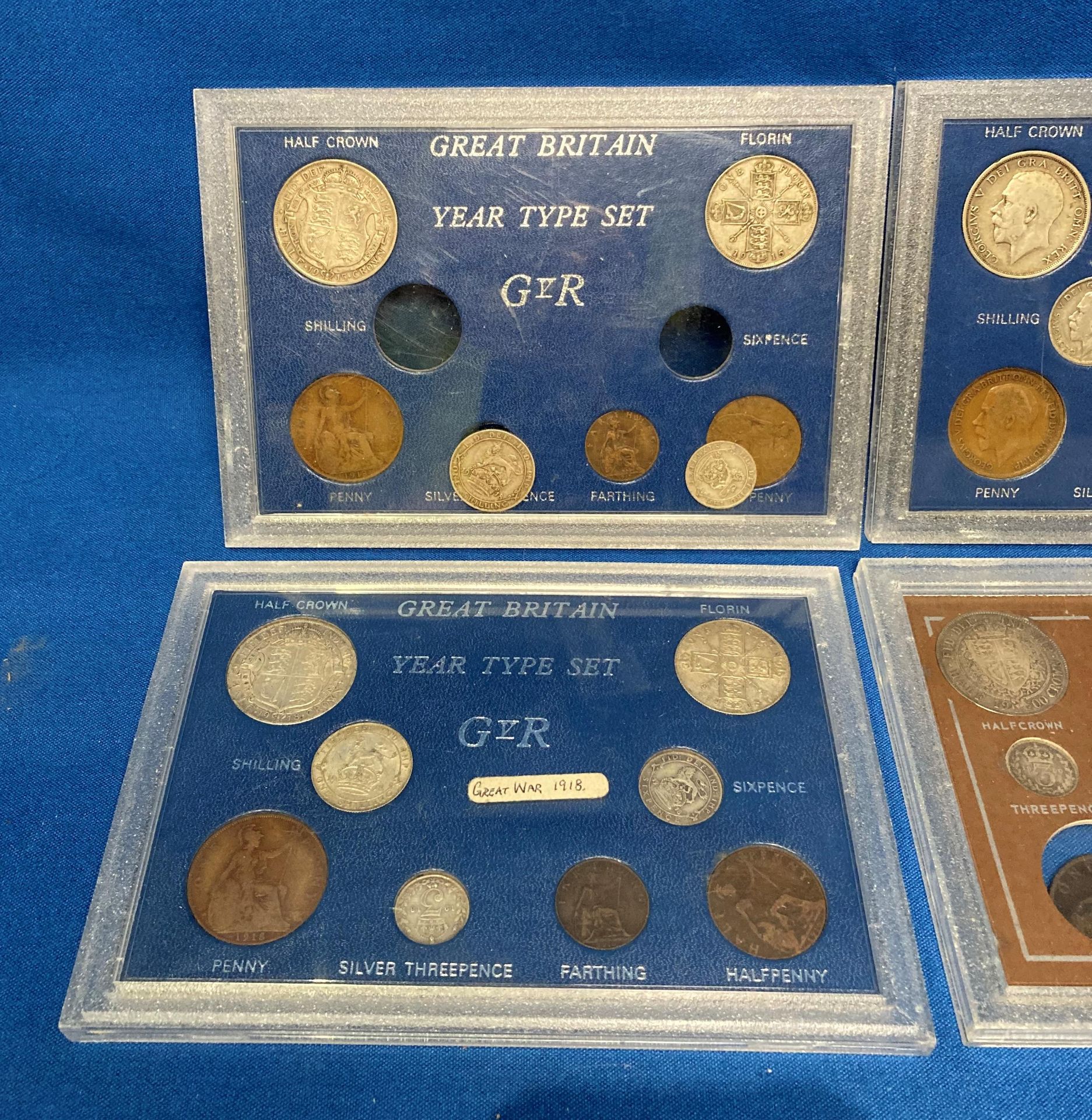 Four Great Britain coin sets in cases including years 1990, 1914, 1915 ...