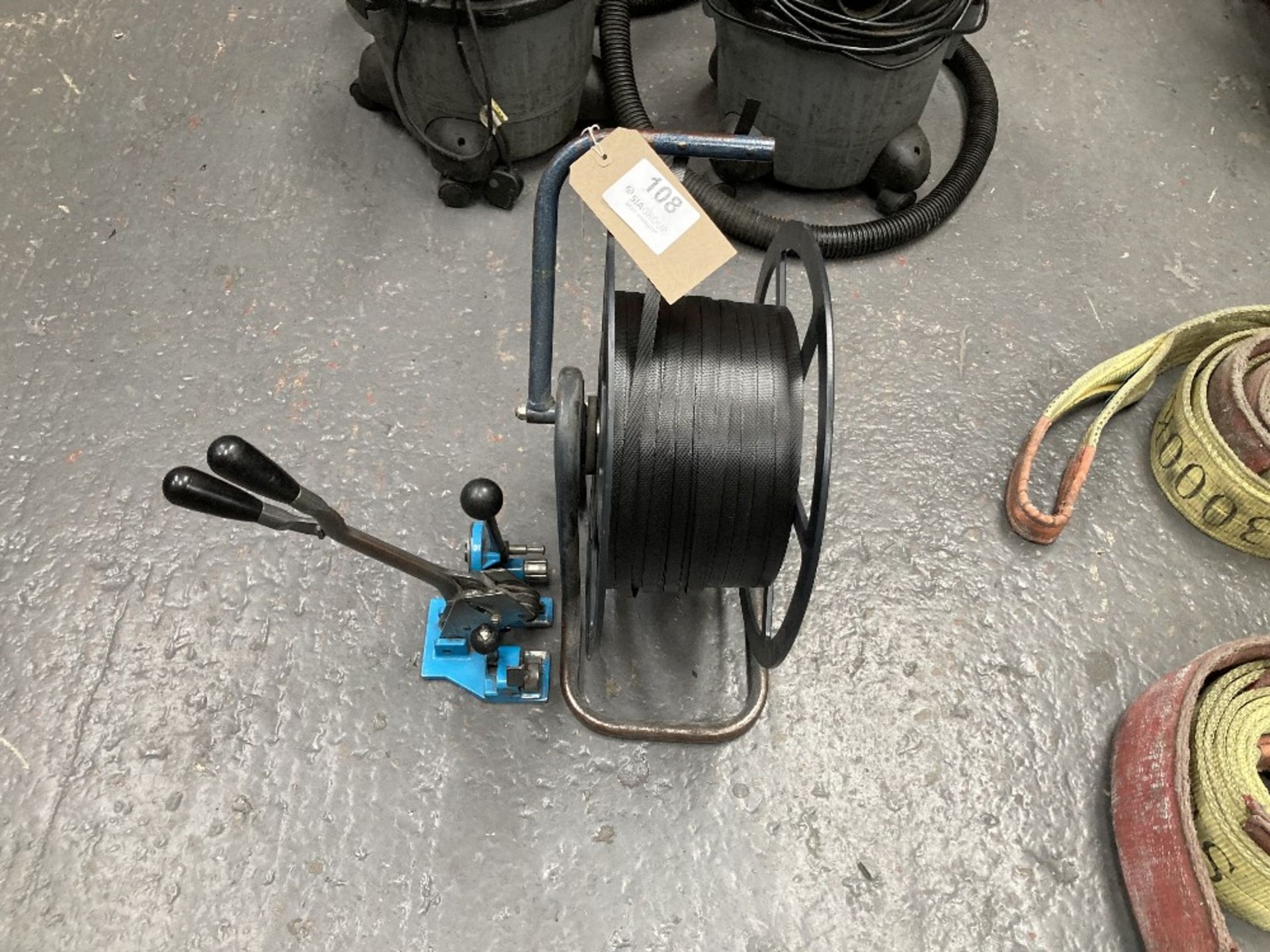 Unbranded steel strap spool feeder with cutter/crimper