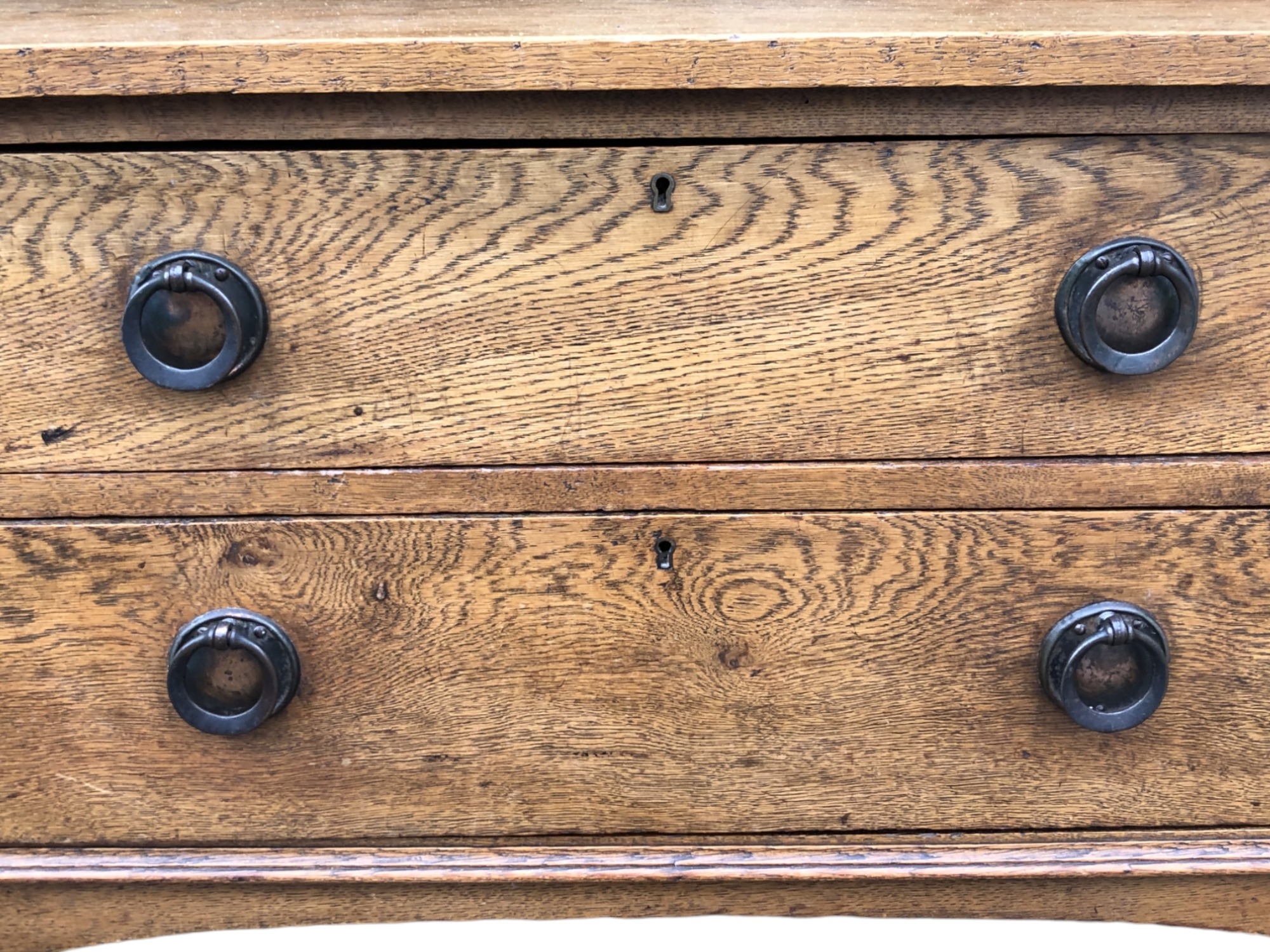 ARTS & CRAFTS OAK TWO-DRAWERS CHEST OF DRAWERS. ON RAISED FEET, WITH ...