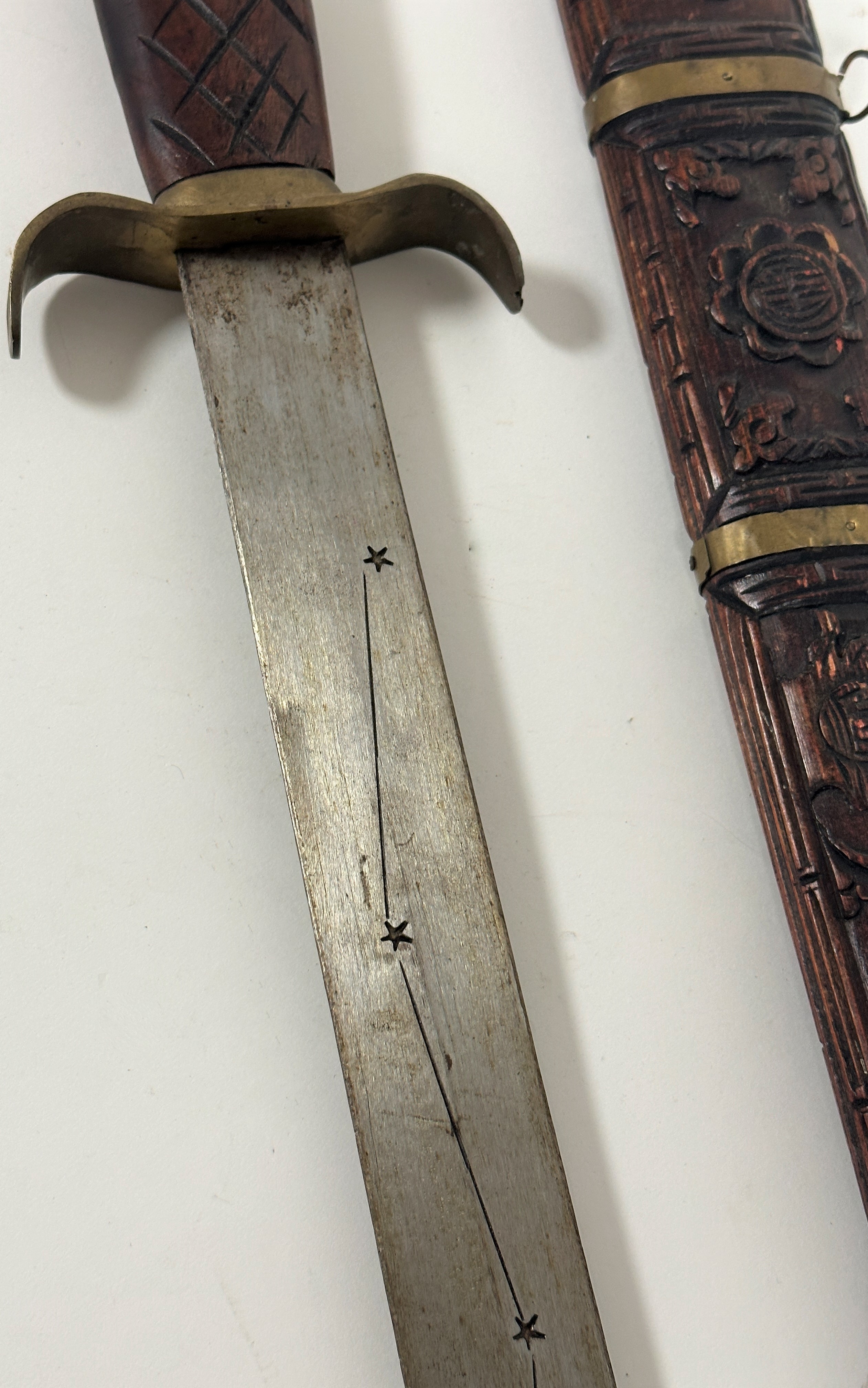 An Eastern teak carved handled sword, complete with carved scabbard ...